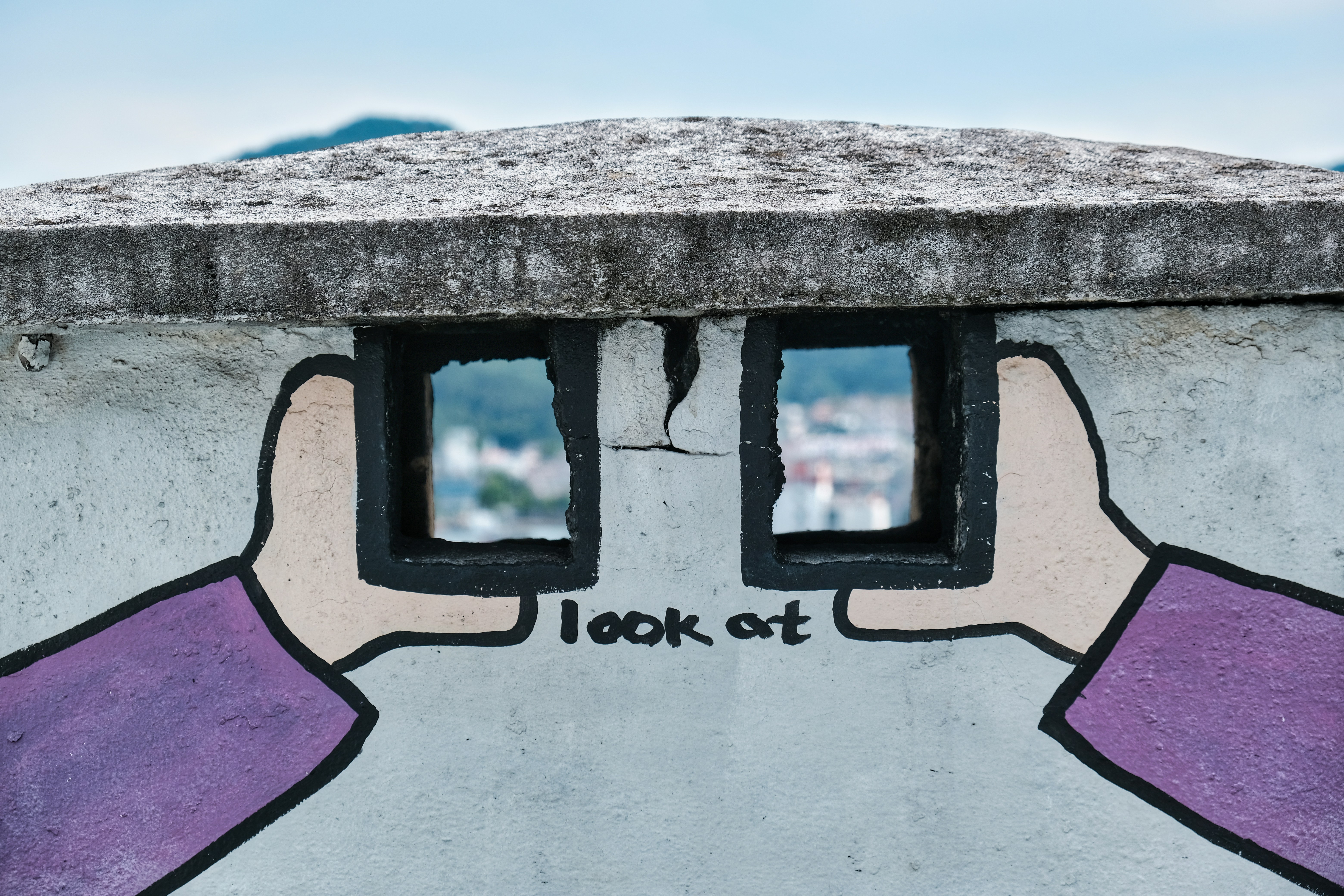 Eyes Through the Wall: A Playful Gaze in Street Art
