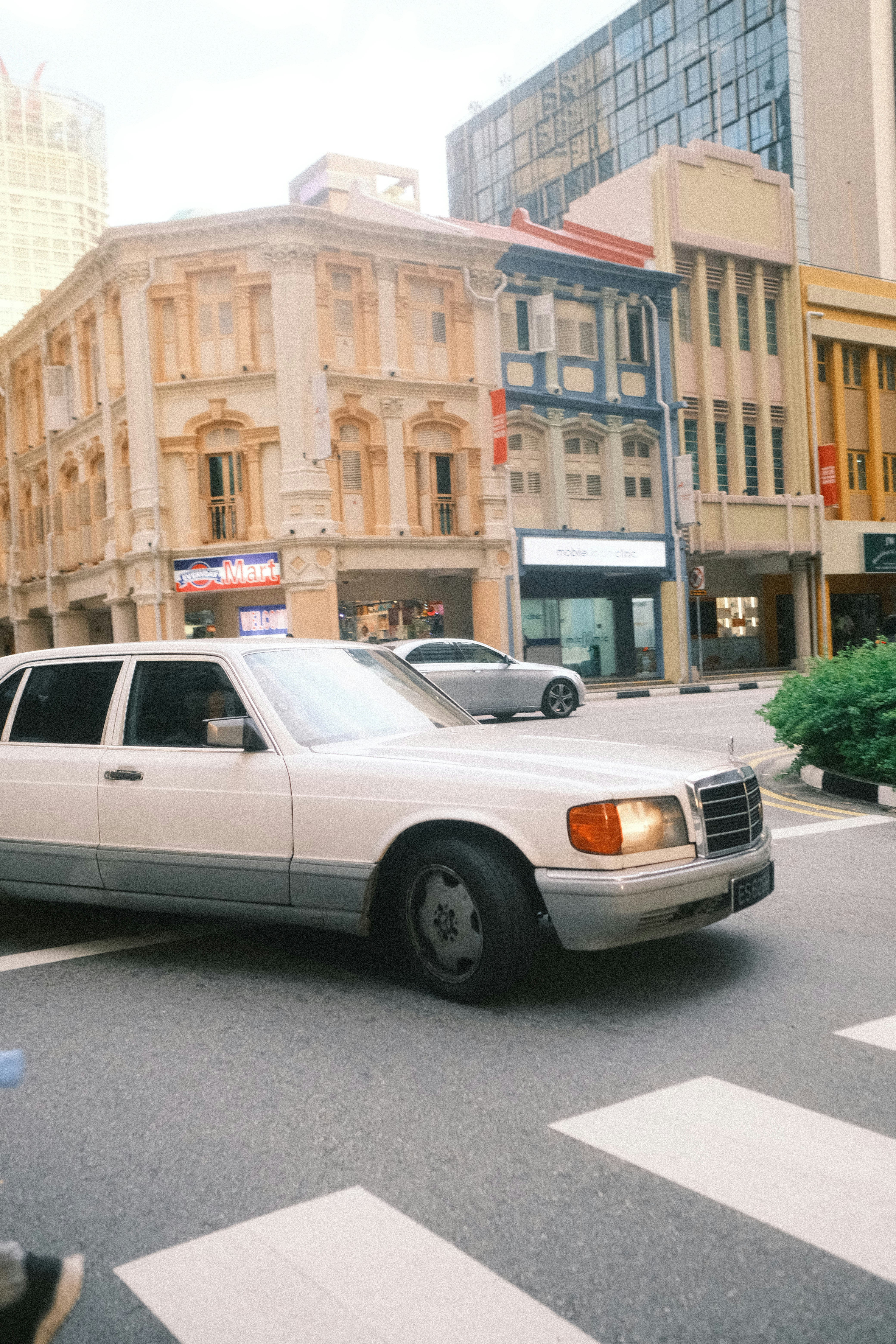 Crosswalk Chronicle: A Classic Mercedes Navigates a Palette of Facades