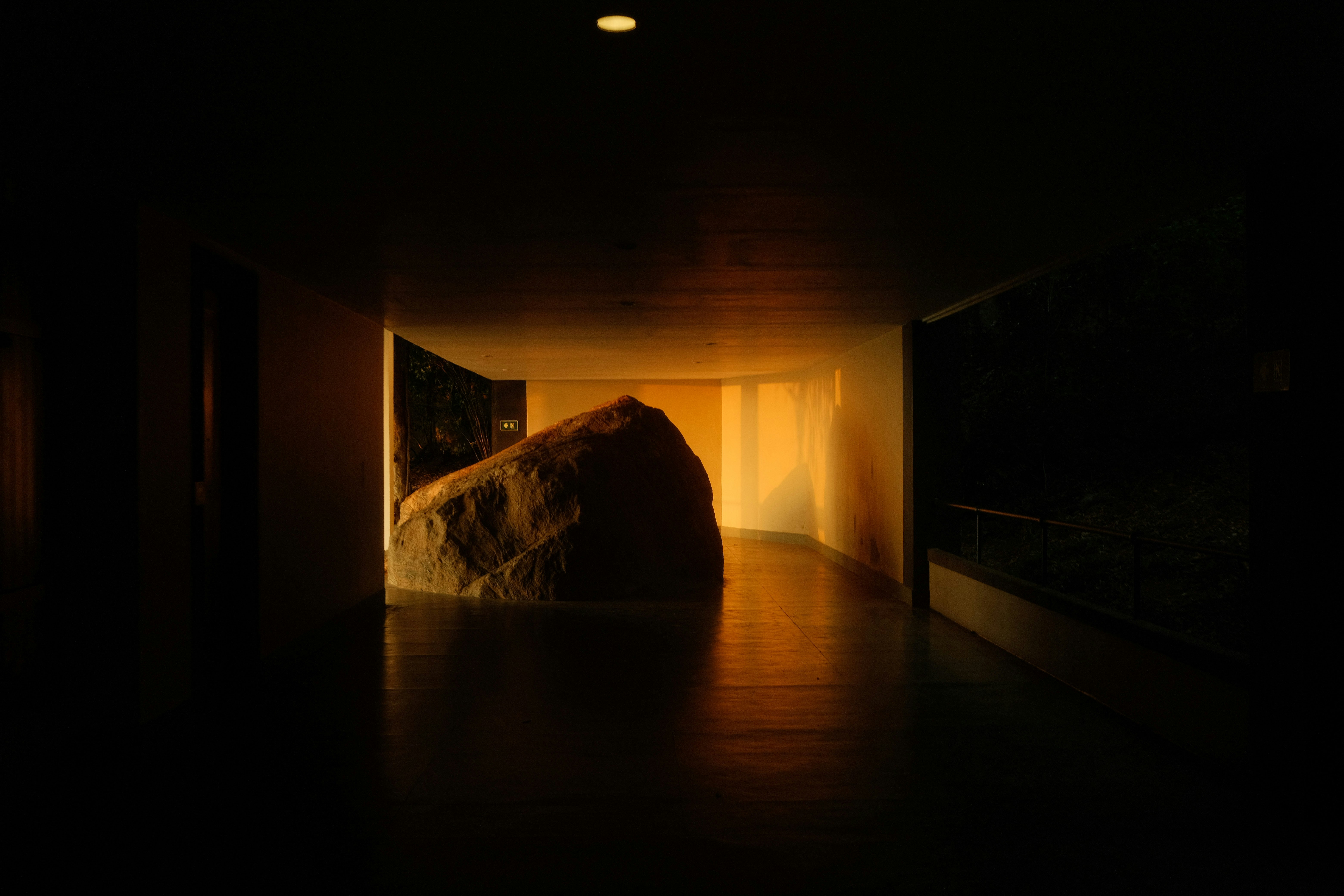 Amber Threshold: A Boulder Stands Guard in the Corridor