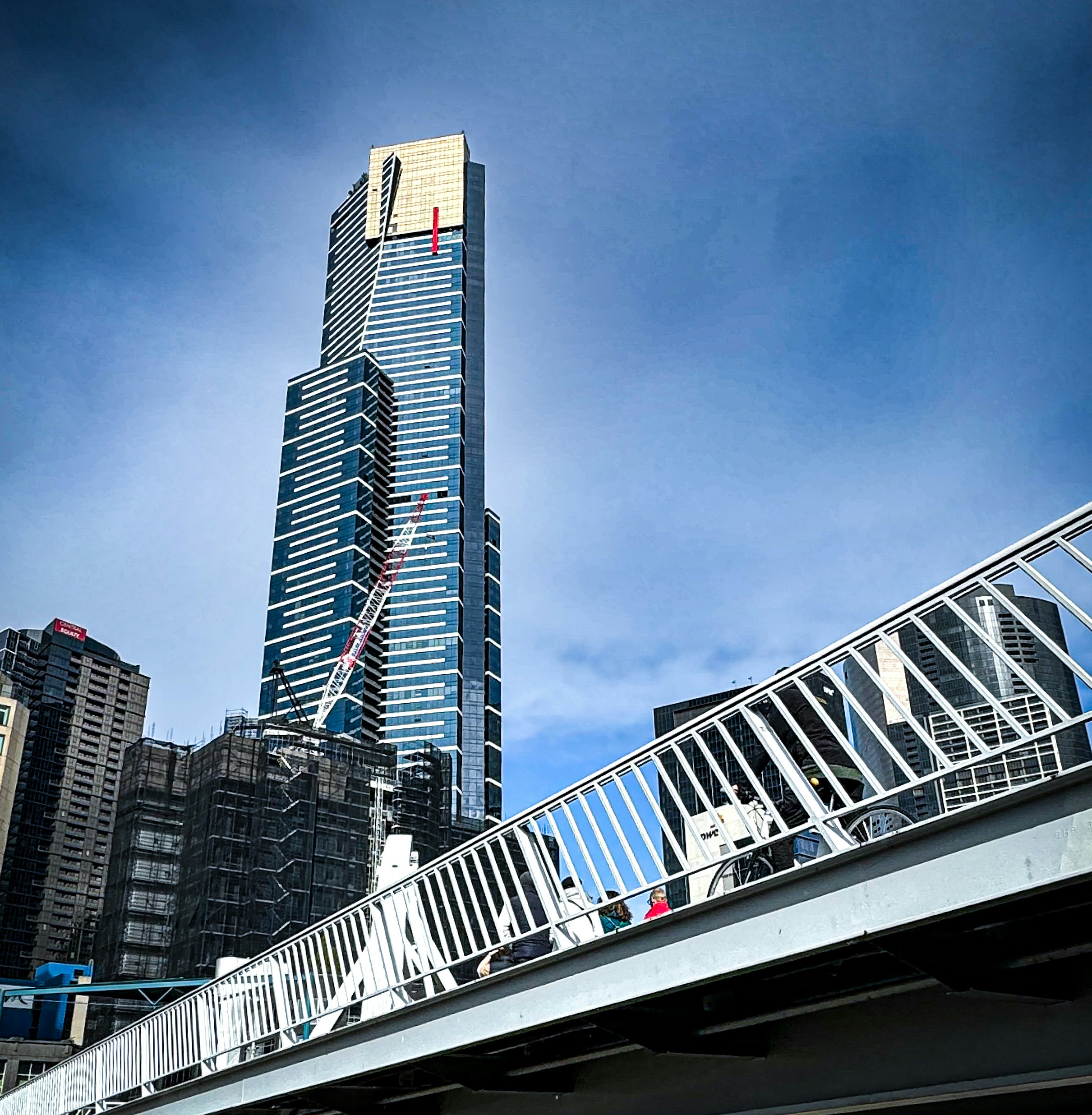 Azure Pinnacle Over the White Spine: A City Tower Framed by a Bridge