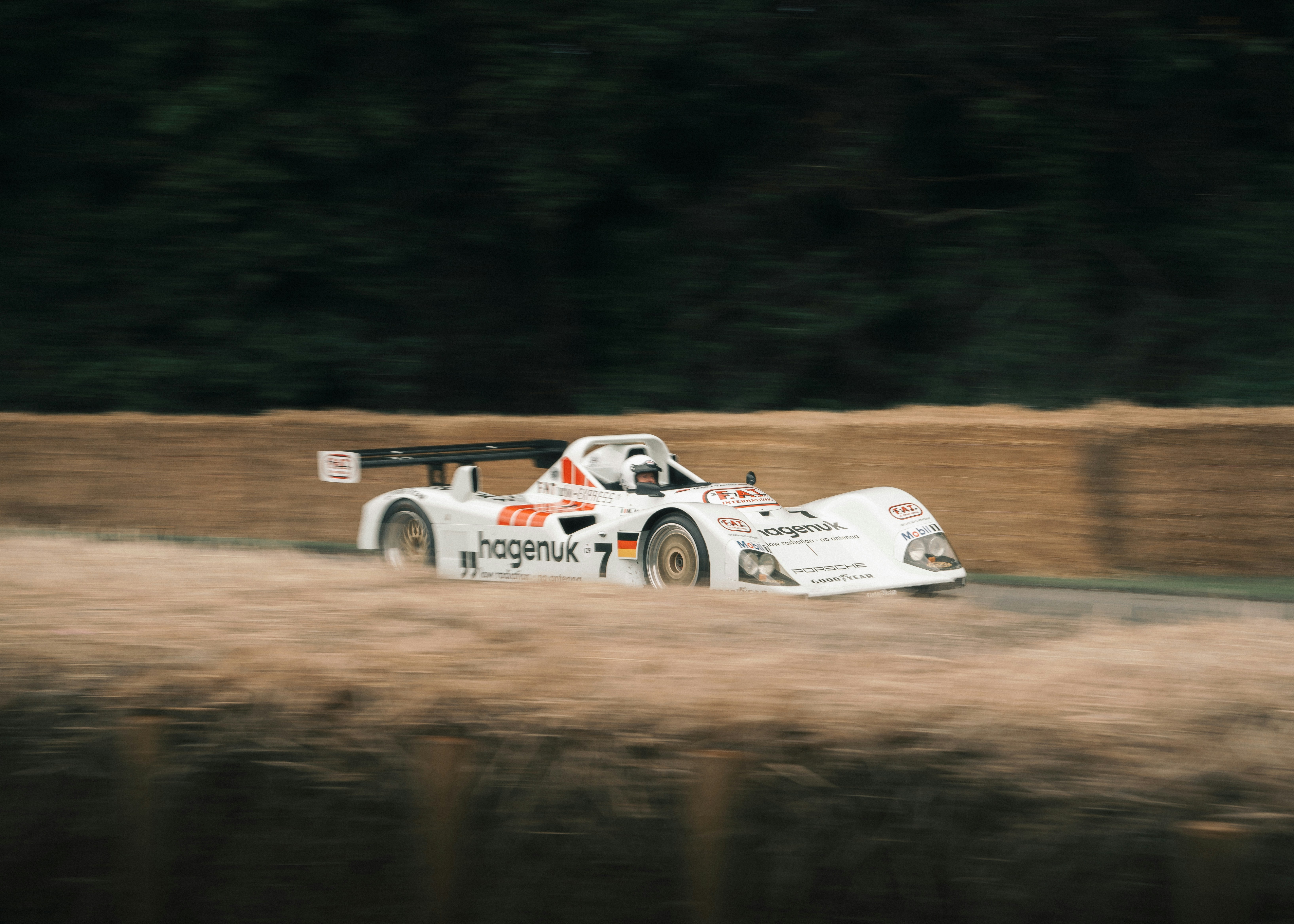 A white race car driving down a dirt road photo – Free Car Image on Unsplash