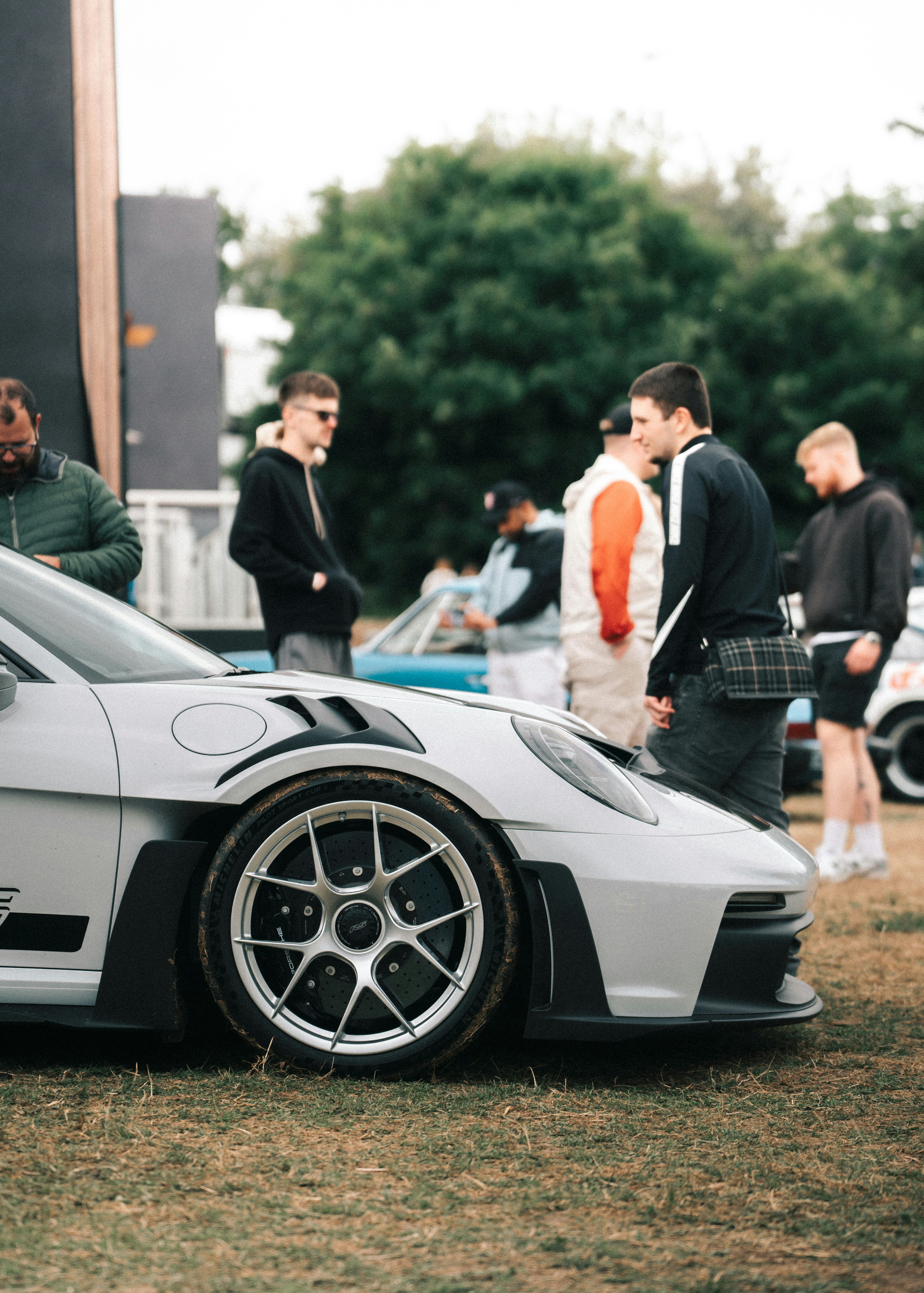 A group of people standing around a white sports car photo – Free Machine Image on Unsplash