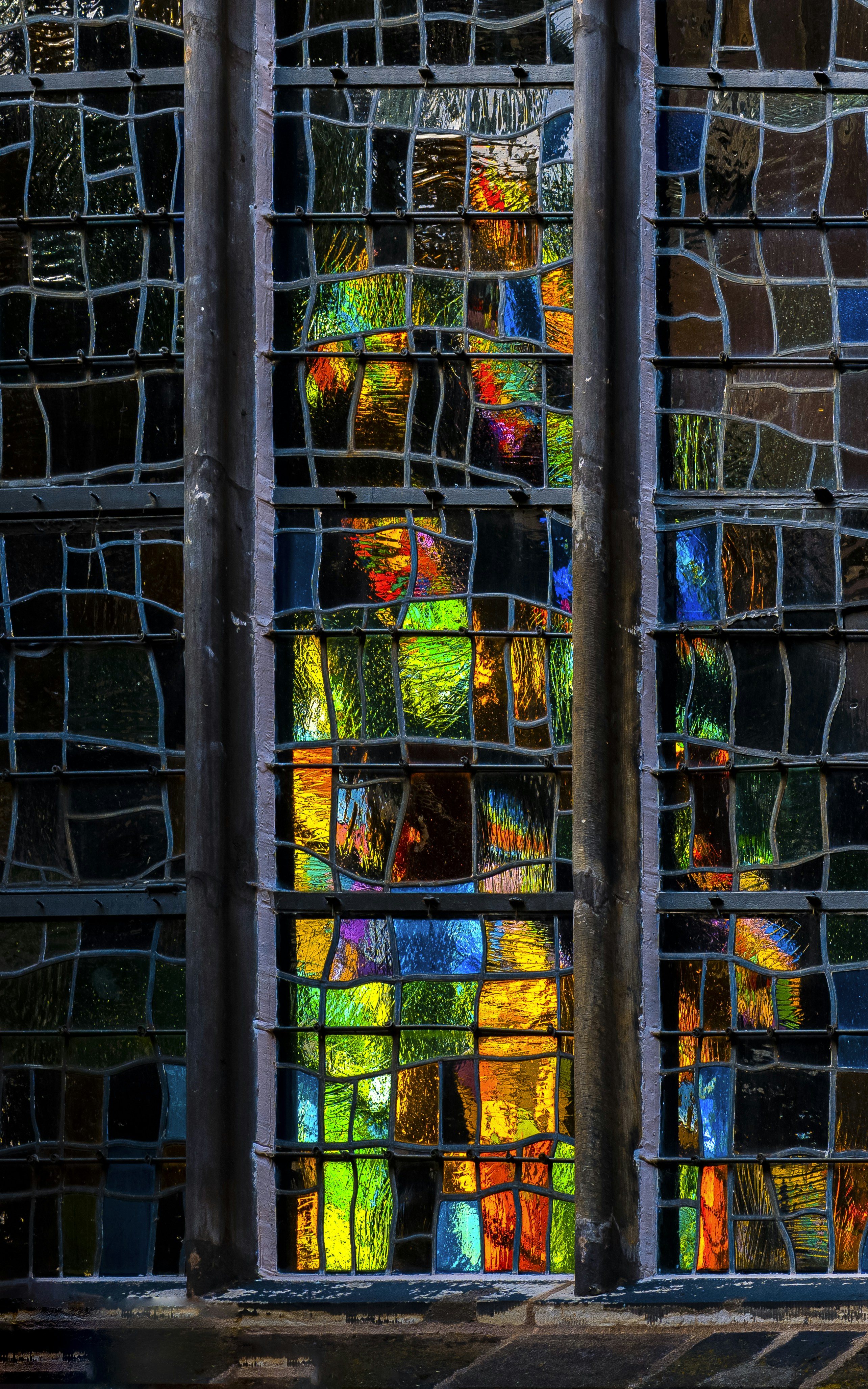 Chromatic Mosaic Behind a Wrought-Iron Grille