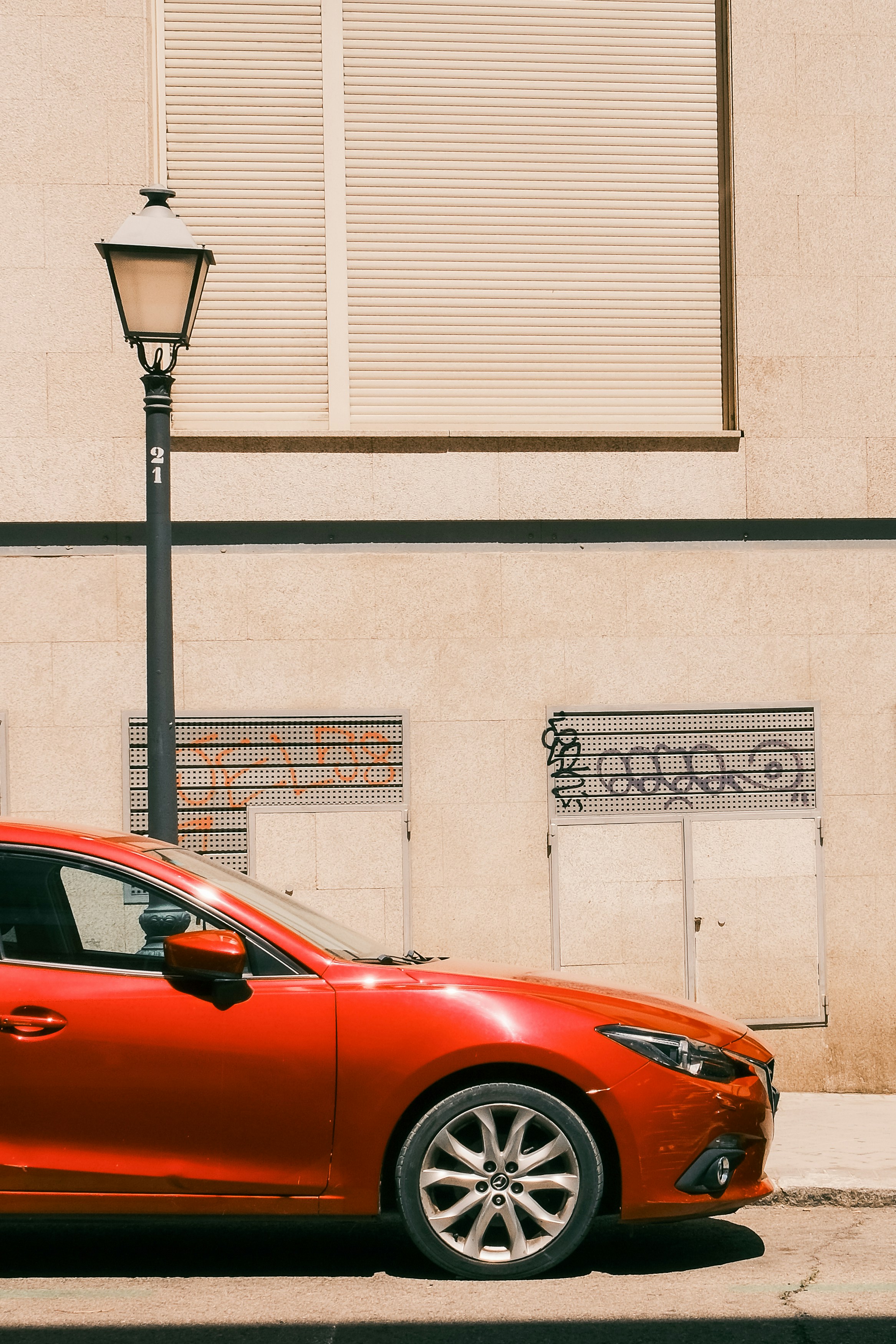Red Pulse of the Street: A Low-Slung Car Under a Quiet City Lamp