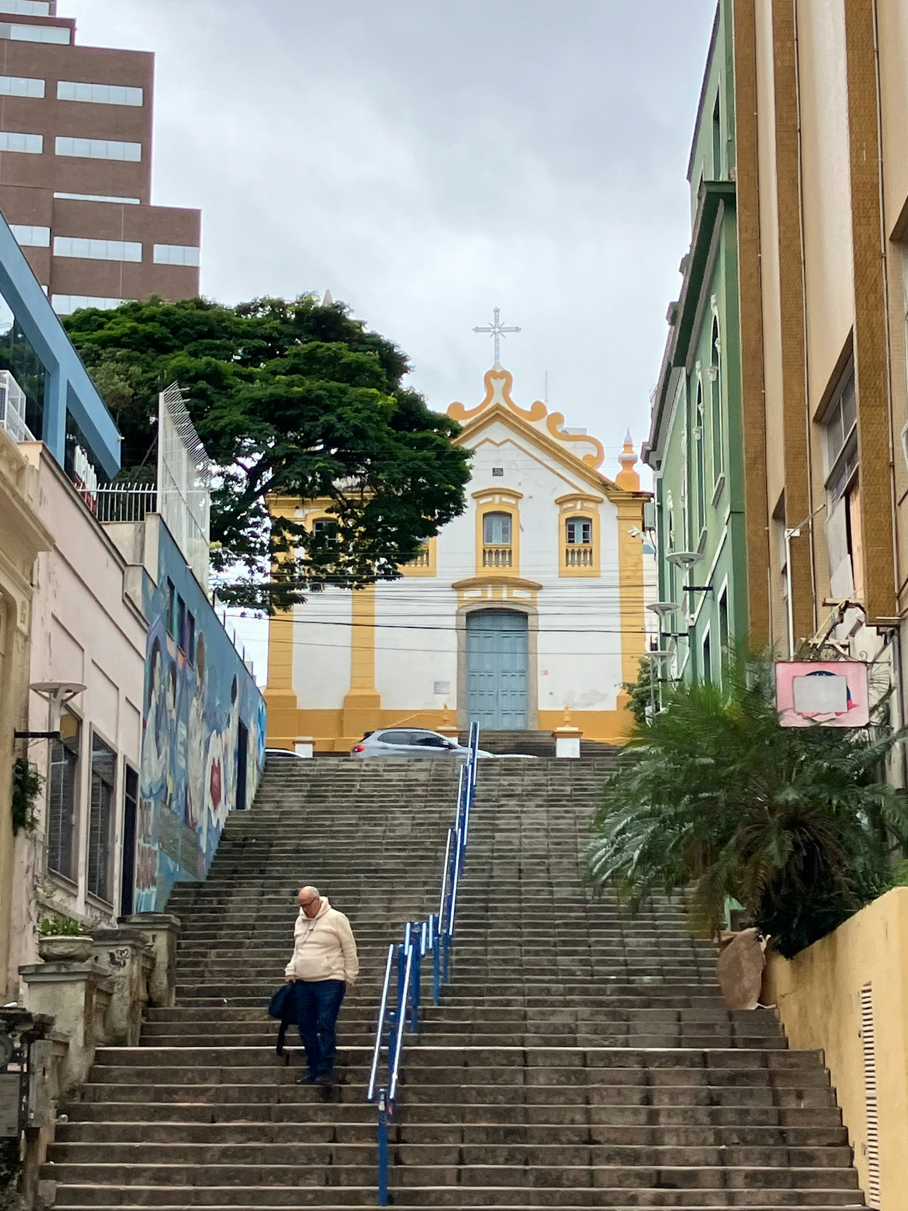Staircase to a church: contrasts of color and urban life