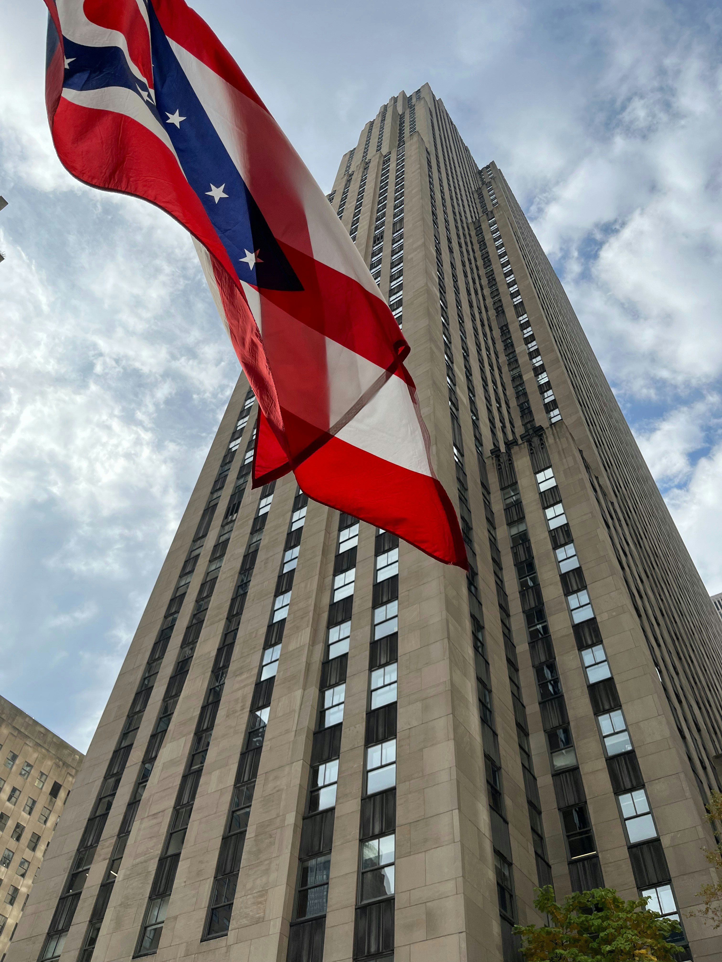 Crimson Flag Framing a Skyward Art Deco Tower