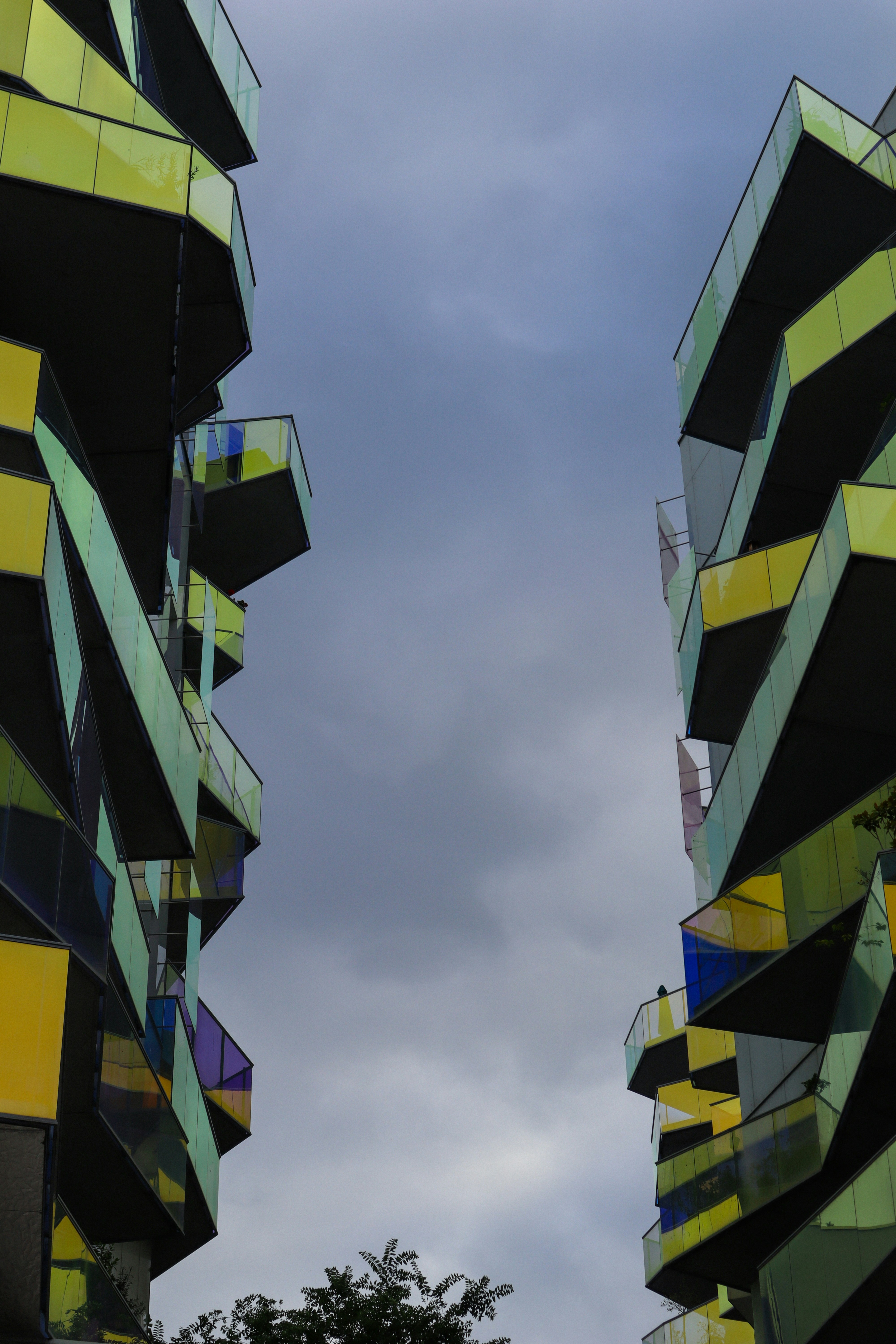 Between Prism Balconies: A Sky-Framed Corridor of Color