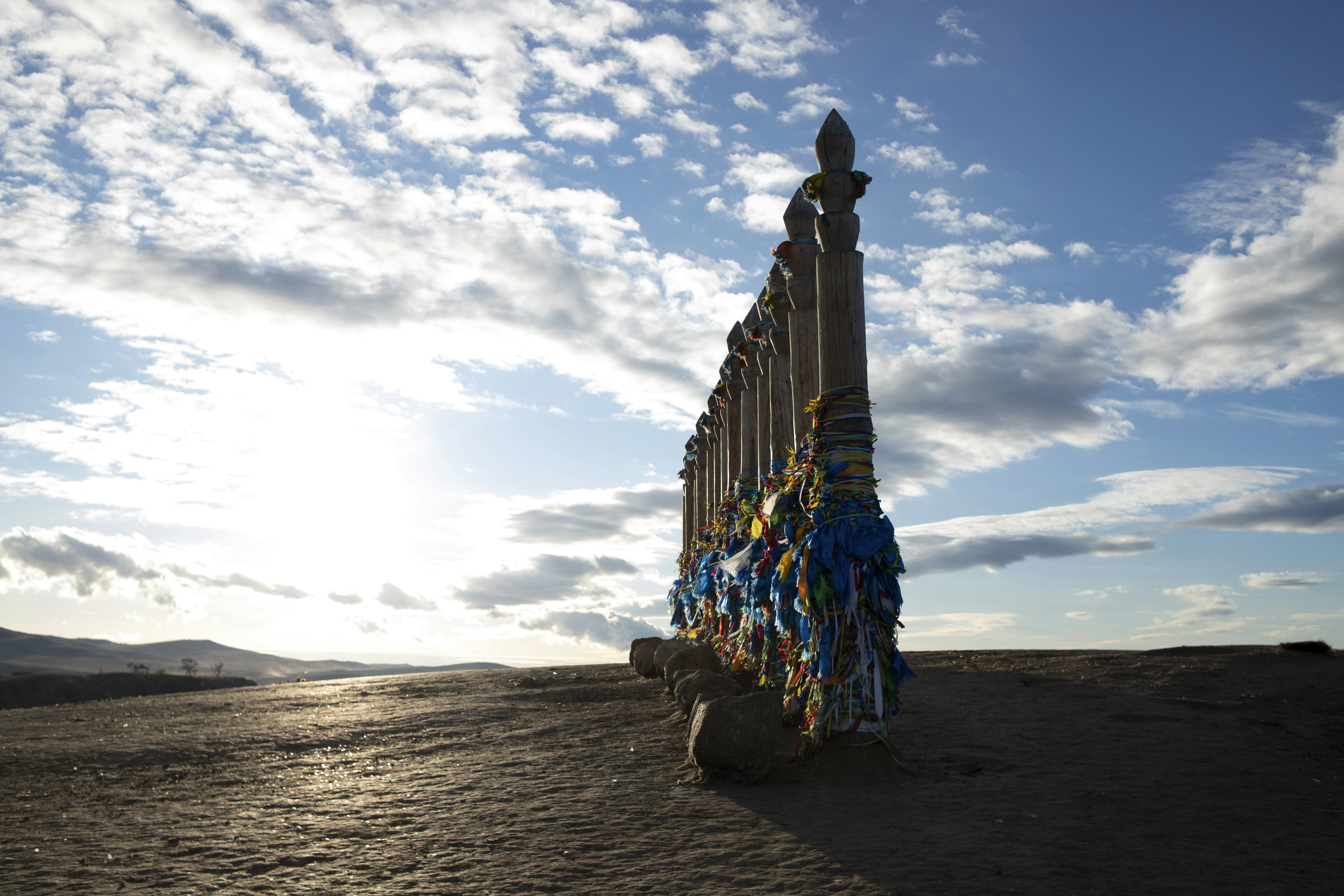 Desert Prayer Fence: Colorful Ribbons Along a Row of Posts