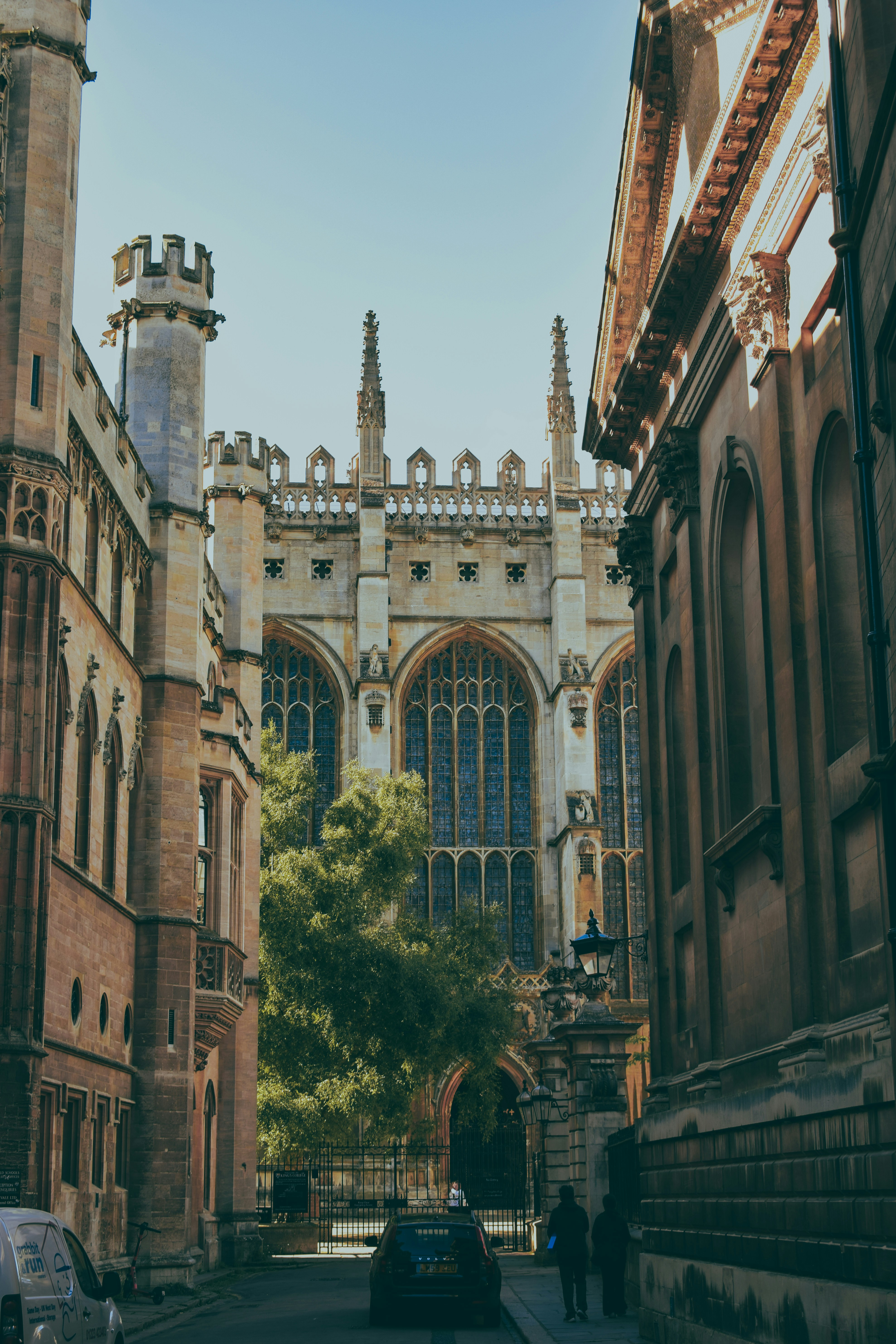 A car driving down a street next to tall buildings
