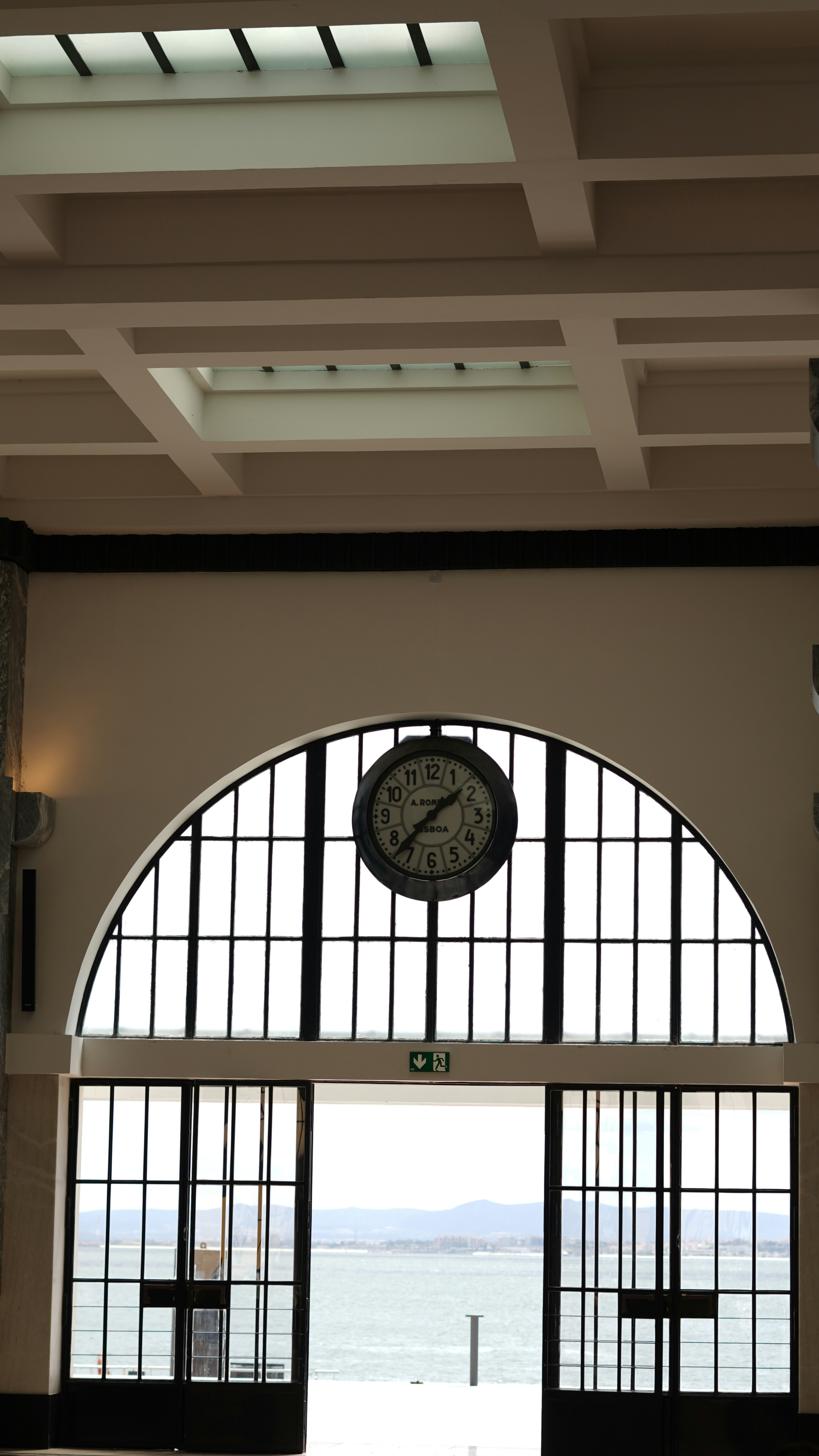 A large clock mounted to the side of a wall