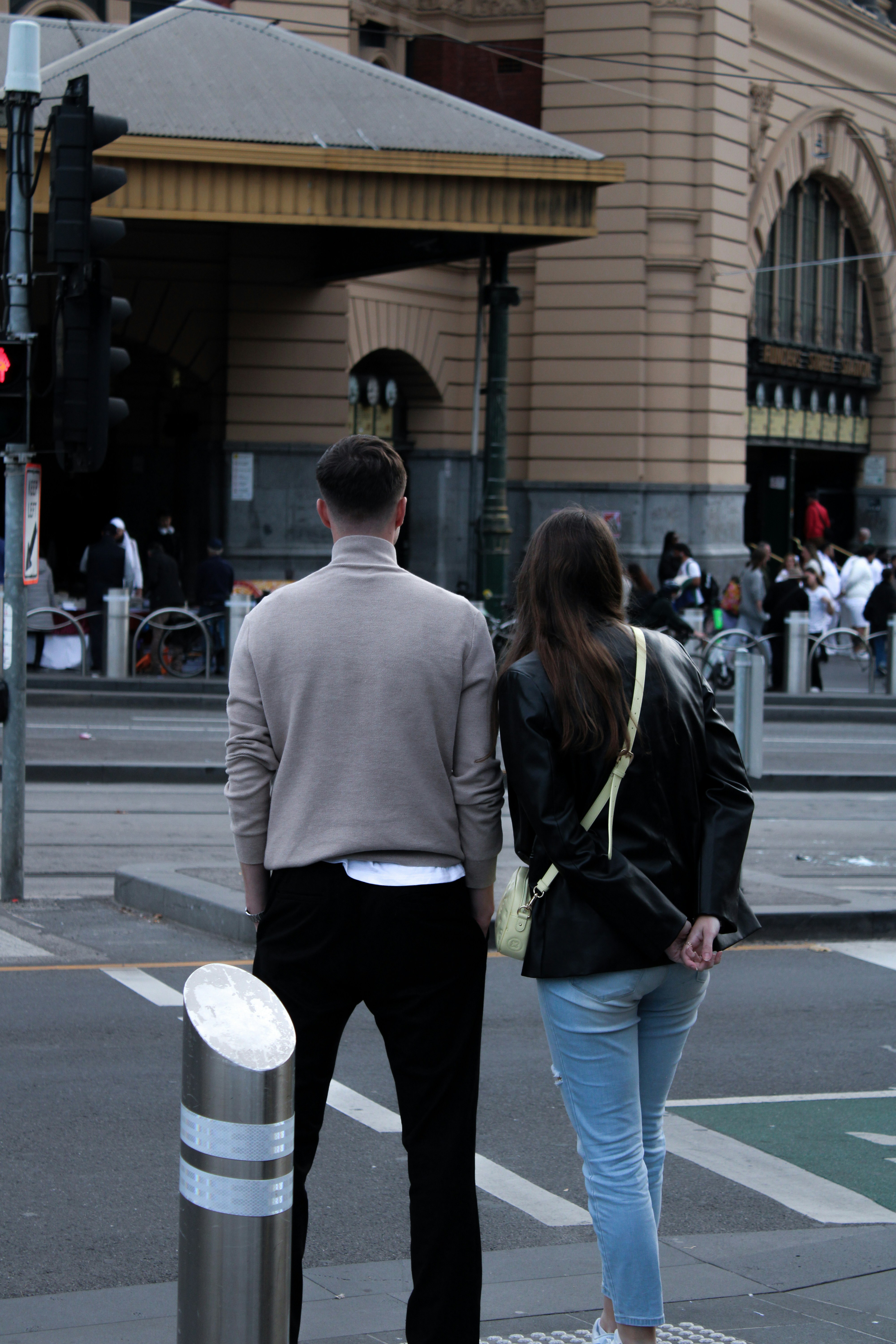 A man and a woman standing on a street corner photo – Free City Image ...