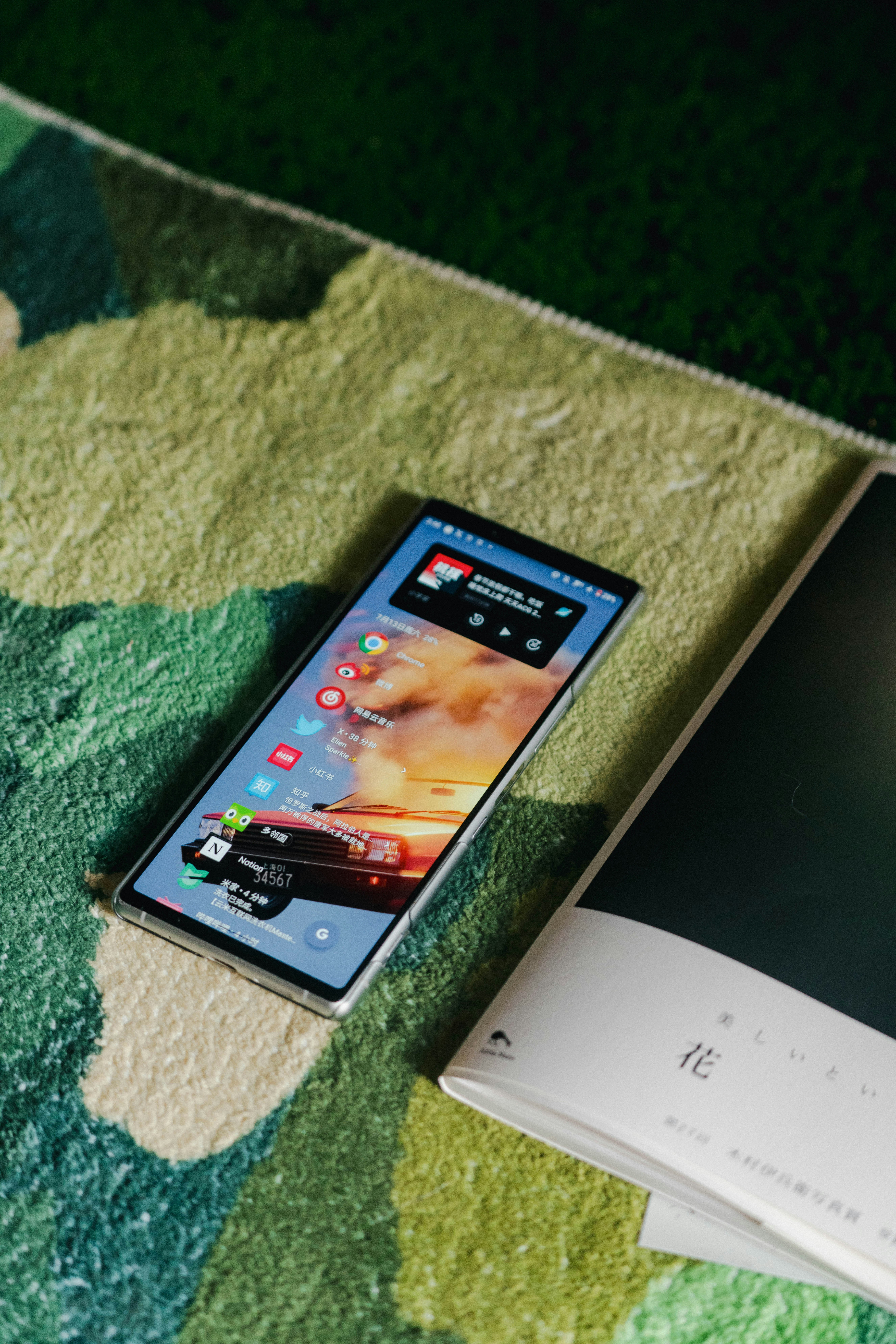 A cell phone sitting on top of a rug photo – Free Cell phone Image on ...