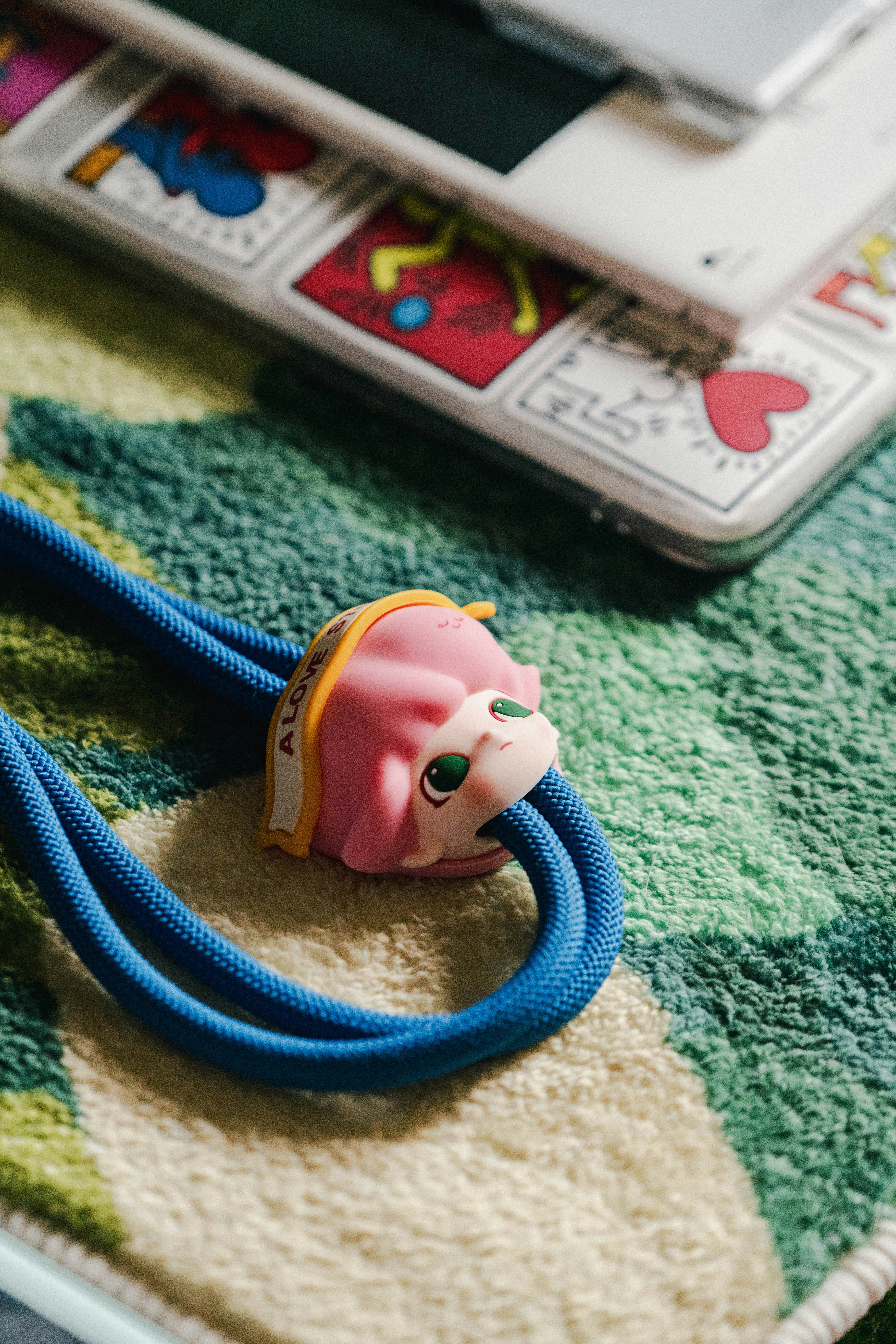 Cheerful Card Games: A Toy Piglet Knotted with a Bristling Blue Rope