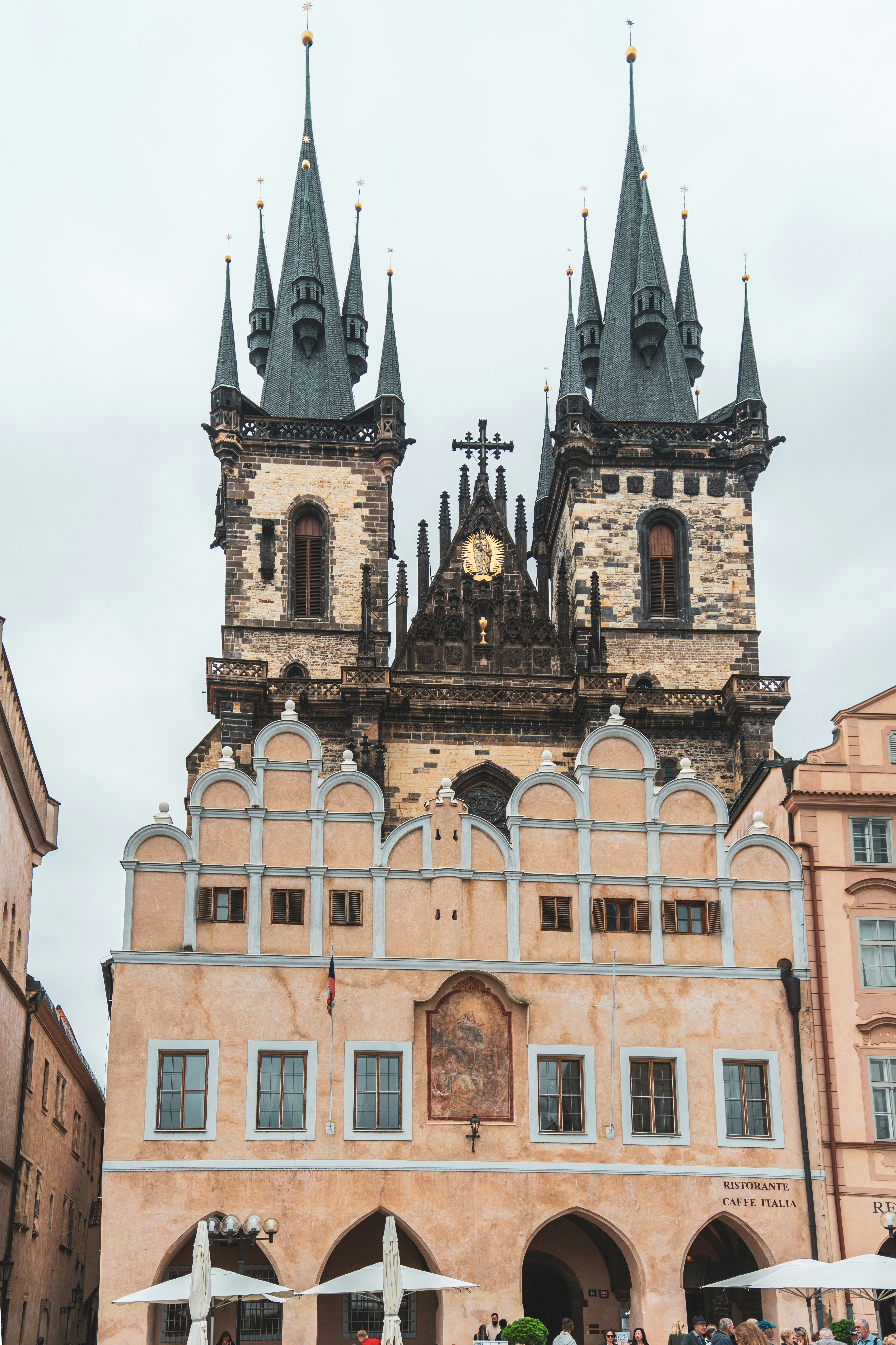 Twin Gothic Spires Over a Peach-Hued Town Hall Facade