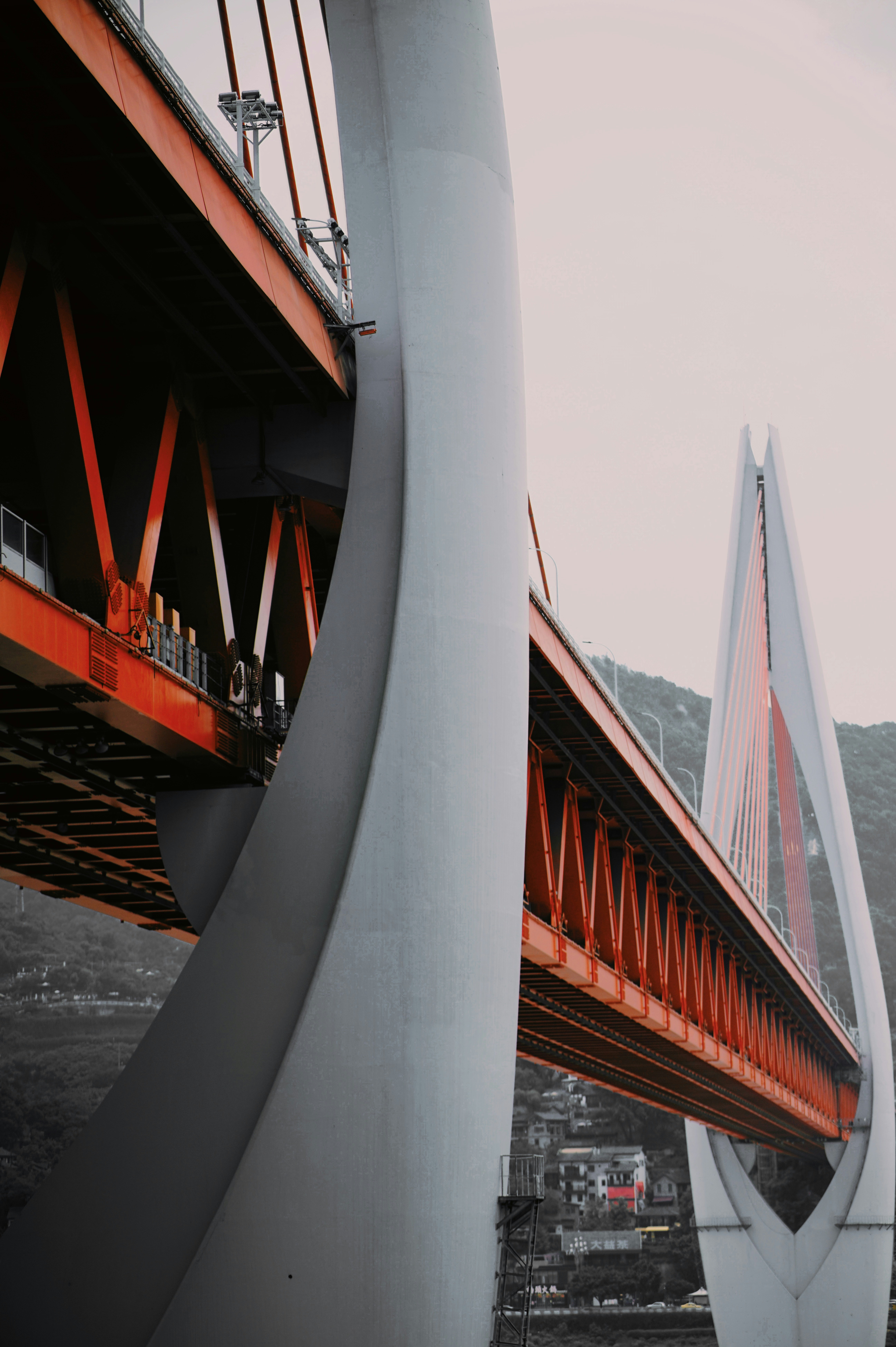 Red Truss Over a White Pylon: Geometry in a Side-On Bridge Portrait