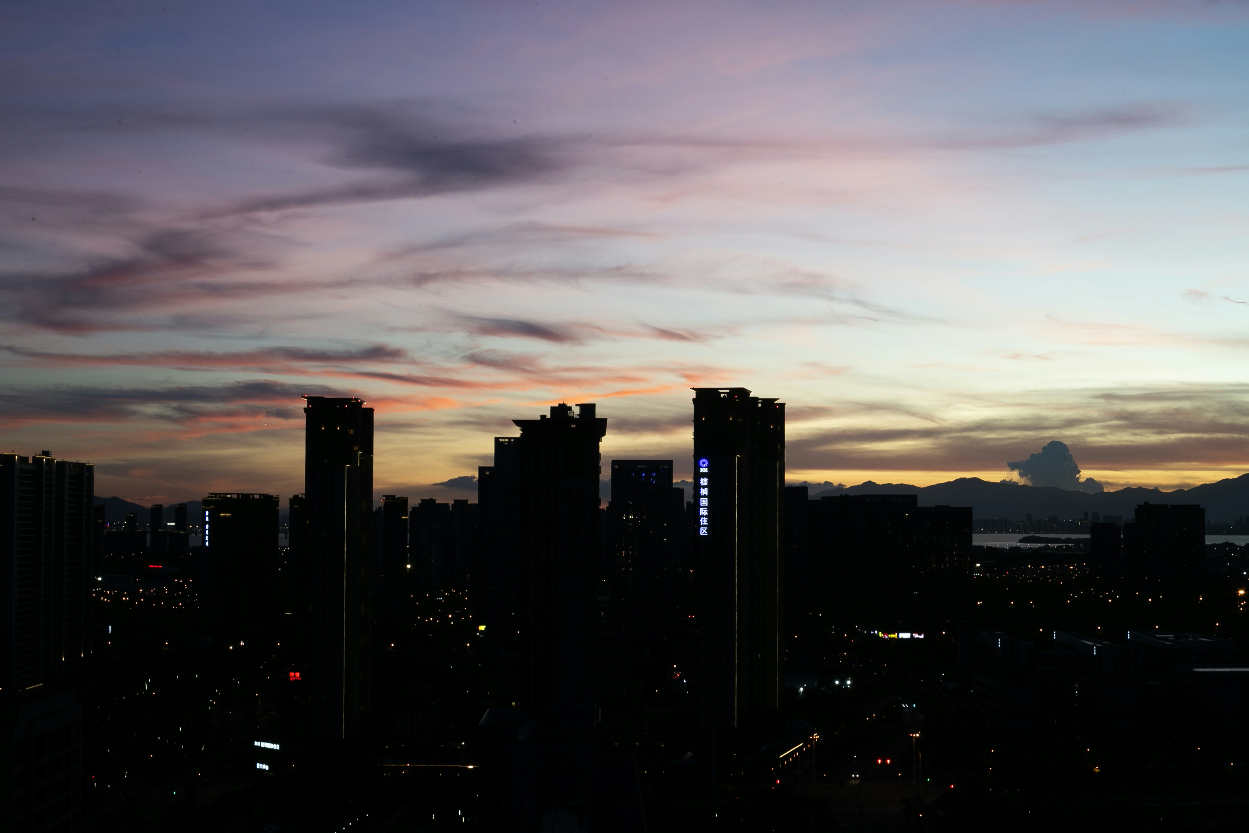 A view of a city at night from the top of a building photo – Free City ...