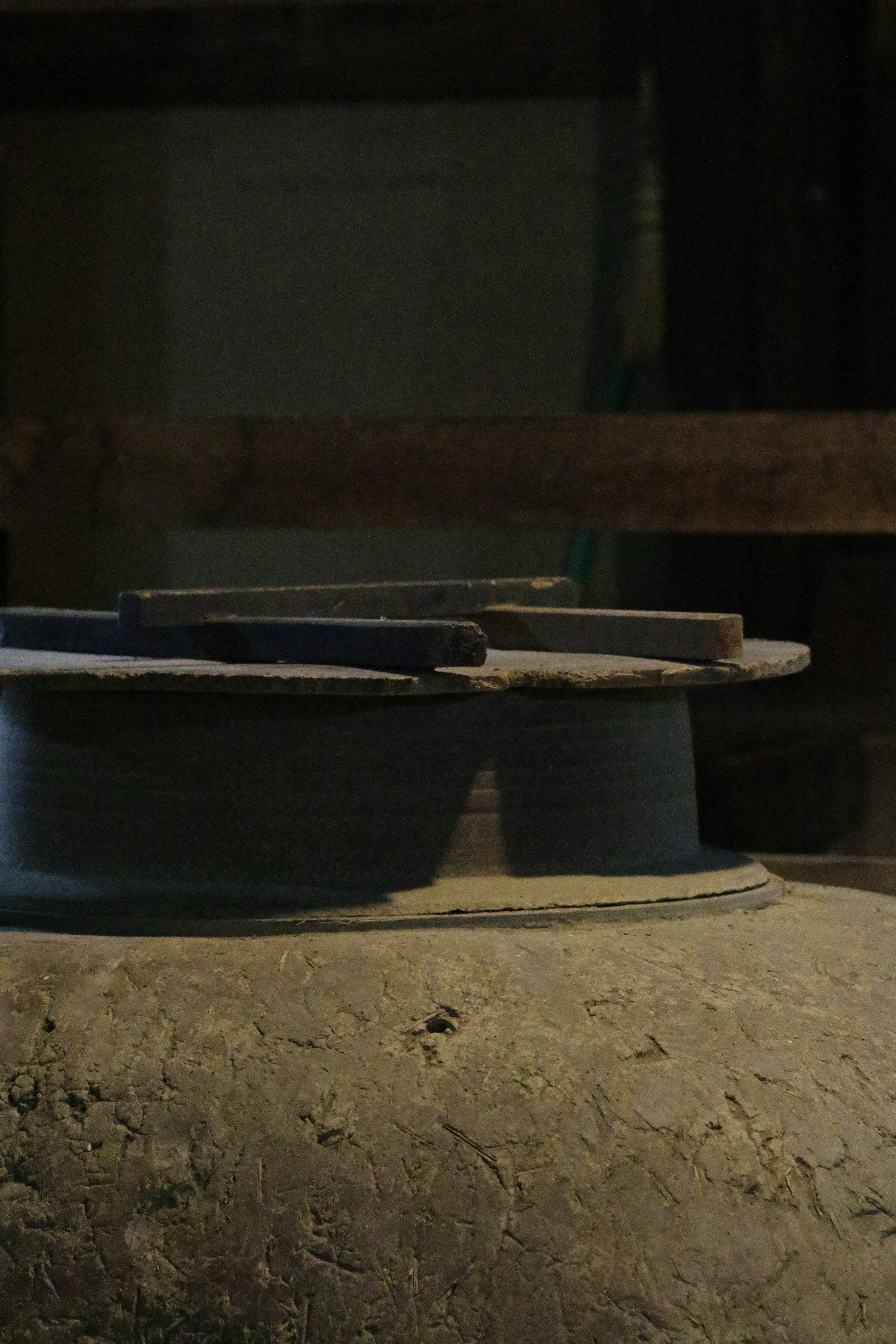 Whisper of Clay: Dim Light on a Pottery Wheel