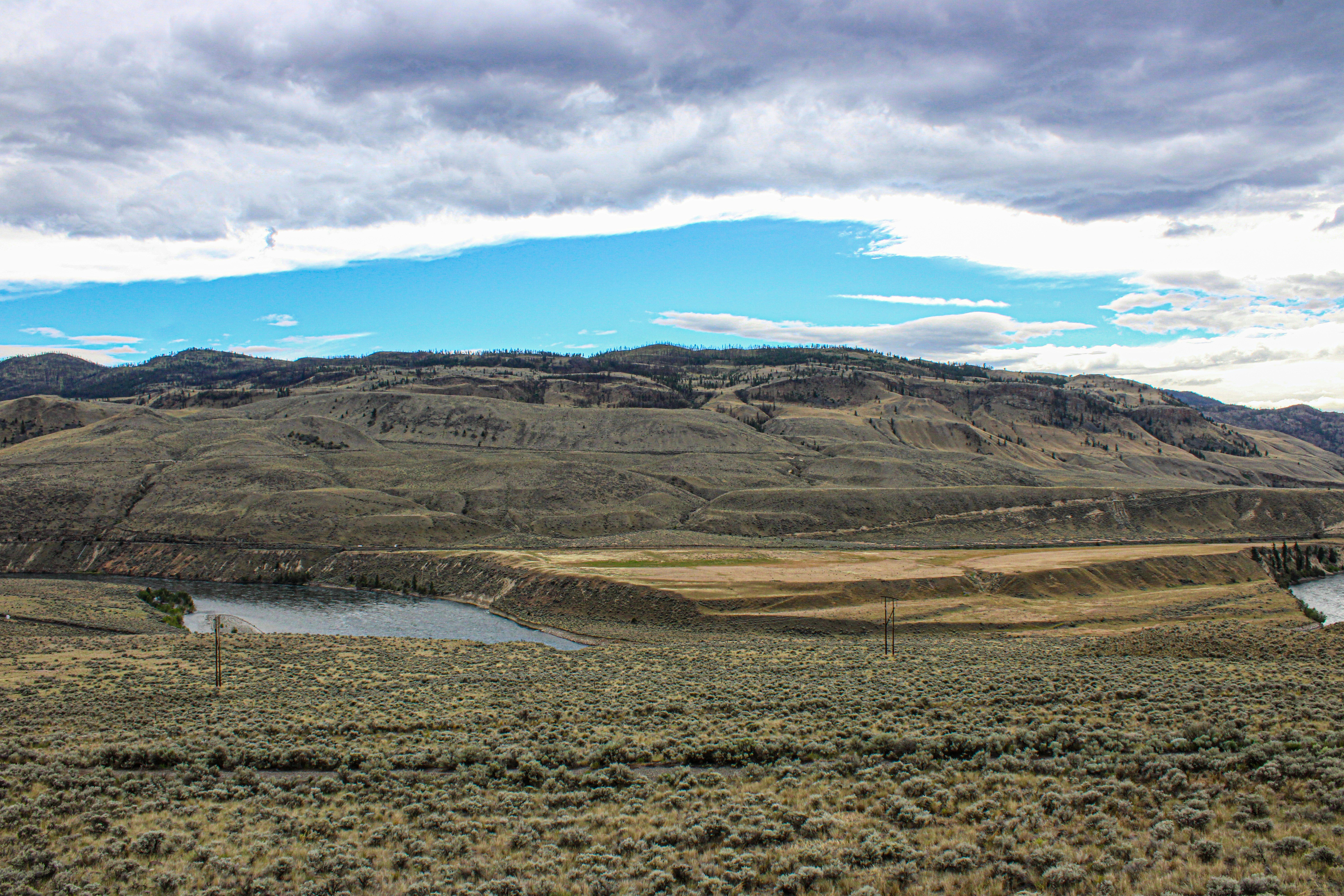 A view of a mountain range with a body of water in the foreground photo ...