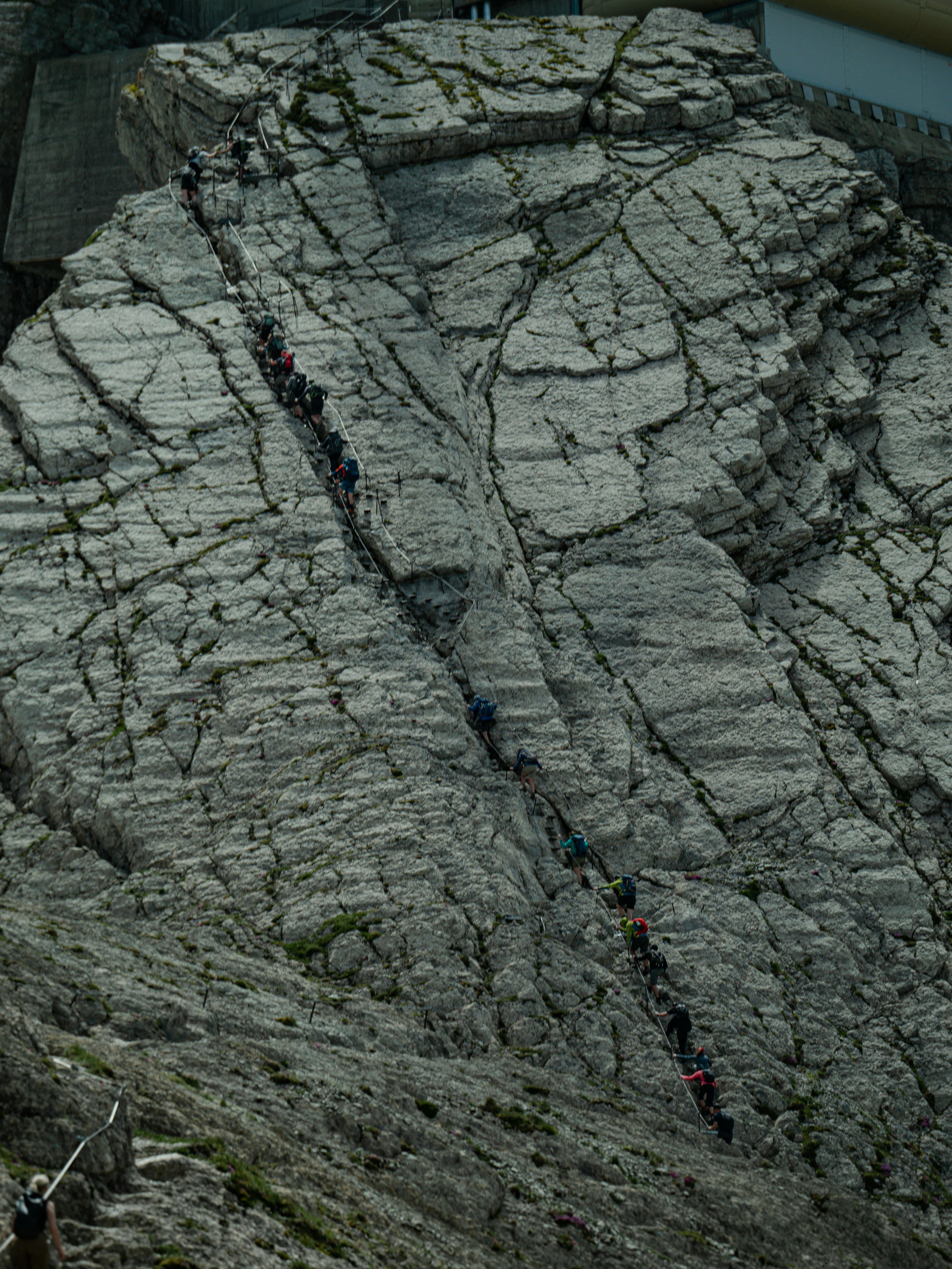 Crackline Ascent: Climbers Thread the Rope Across a Granite Face