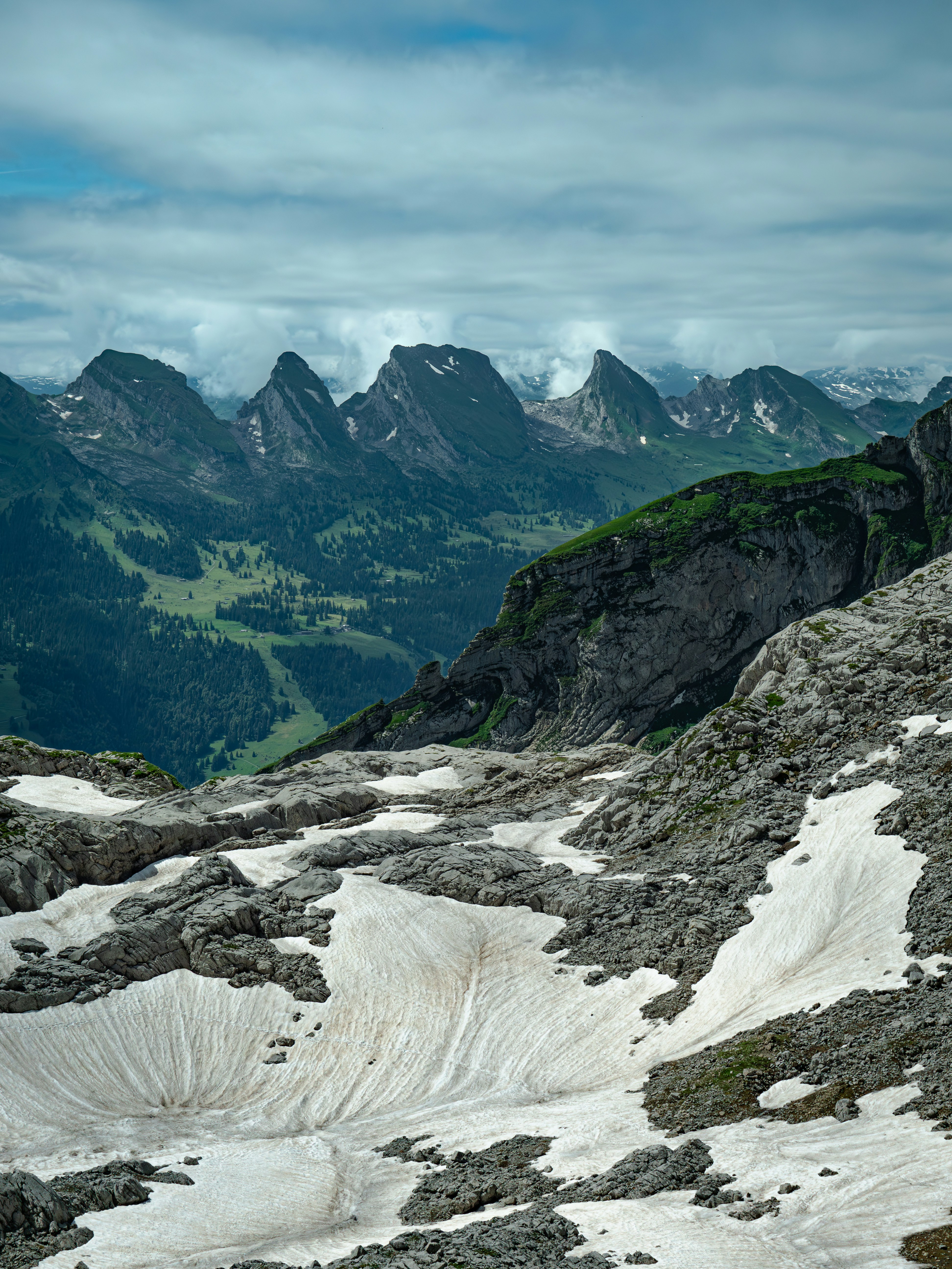 Crag Crown over Snow-etched Slopes: An Alpine Panorama