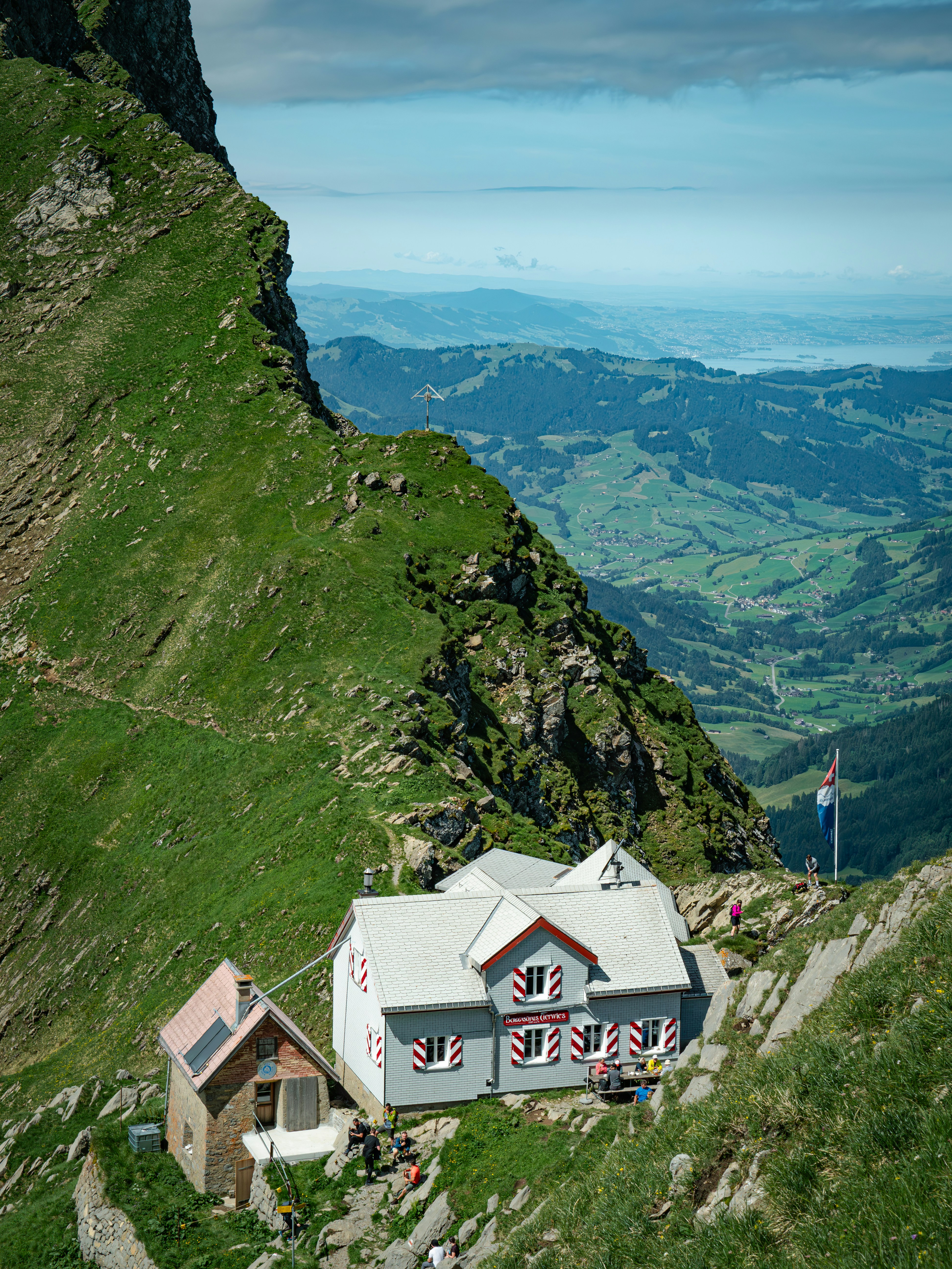 A house sitting on top of a lush green hillside