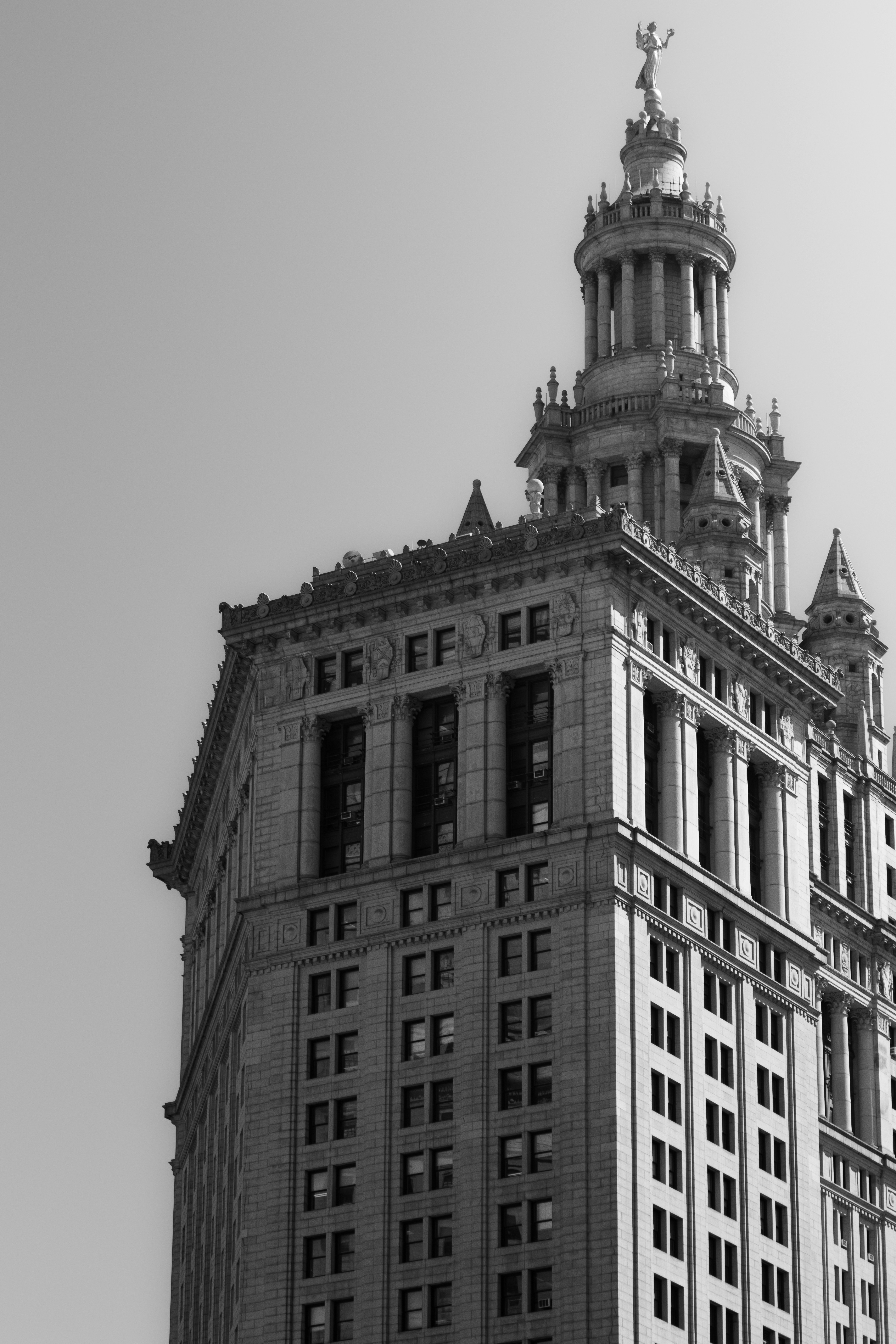 Top of Time: A Statue-Topped Tower Reaching the Sky