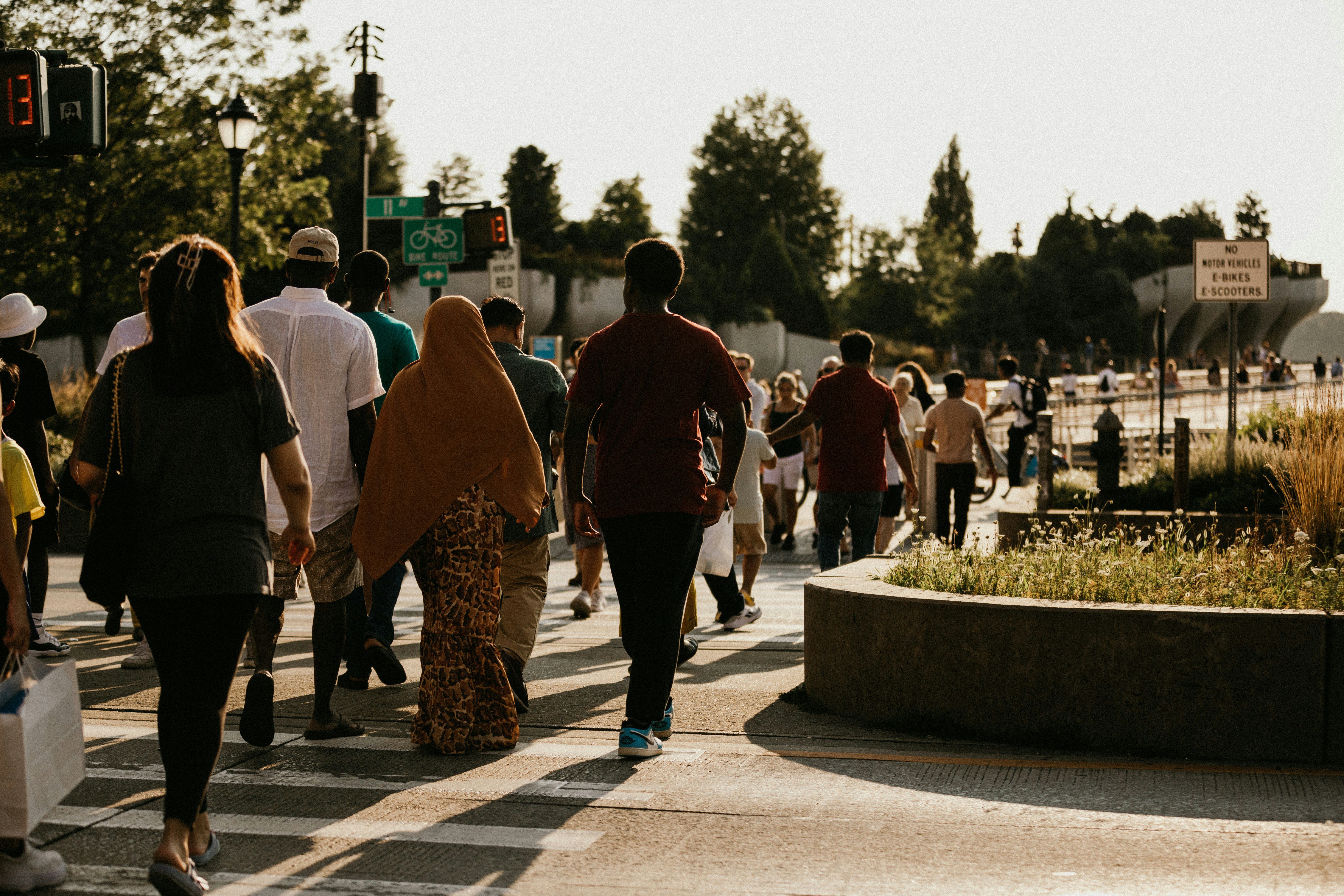 A group of people walking across a cross walk photo – Free New york ...