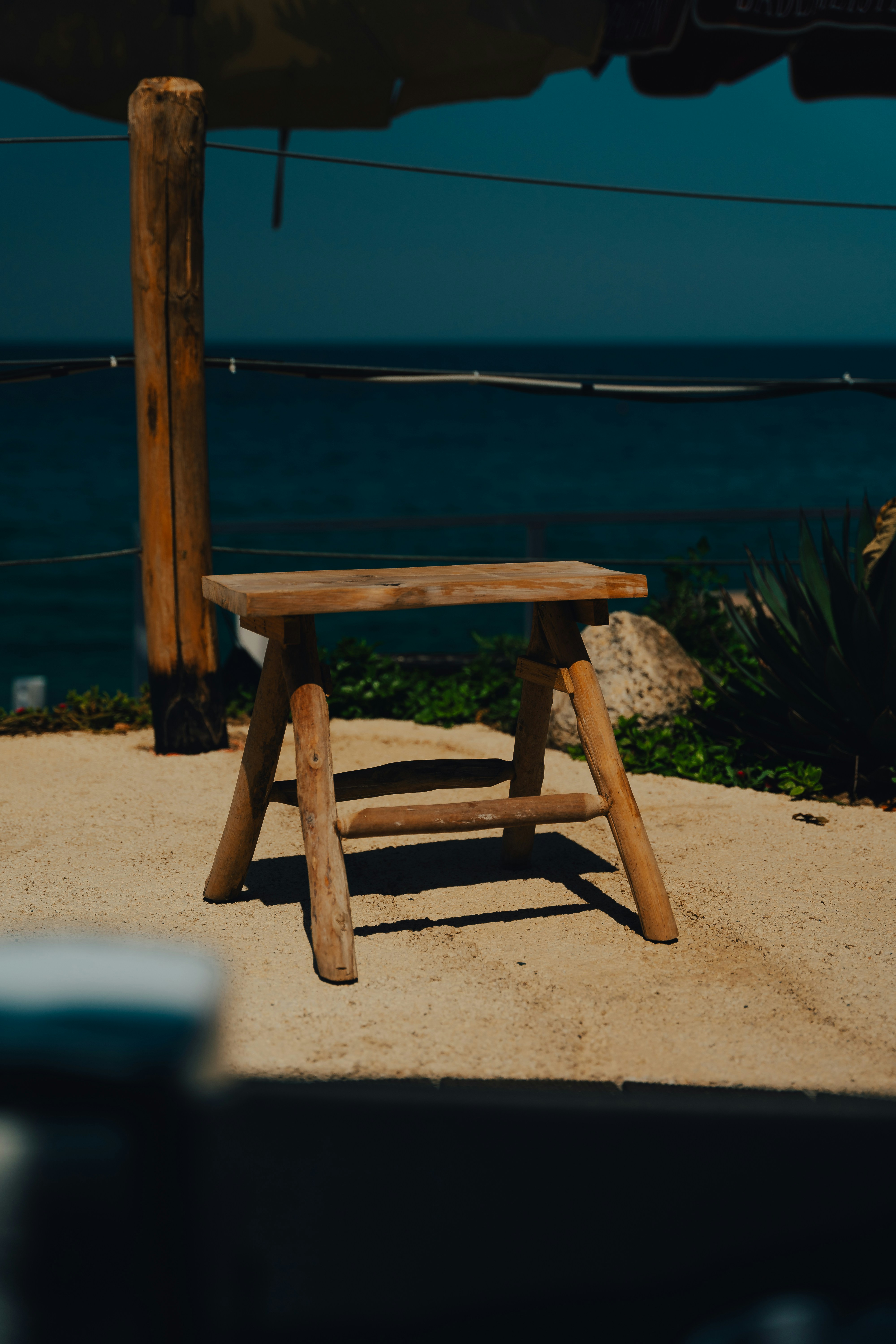 Sun-Warmed Wooden Bench at the Sand-Sea Edge