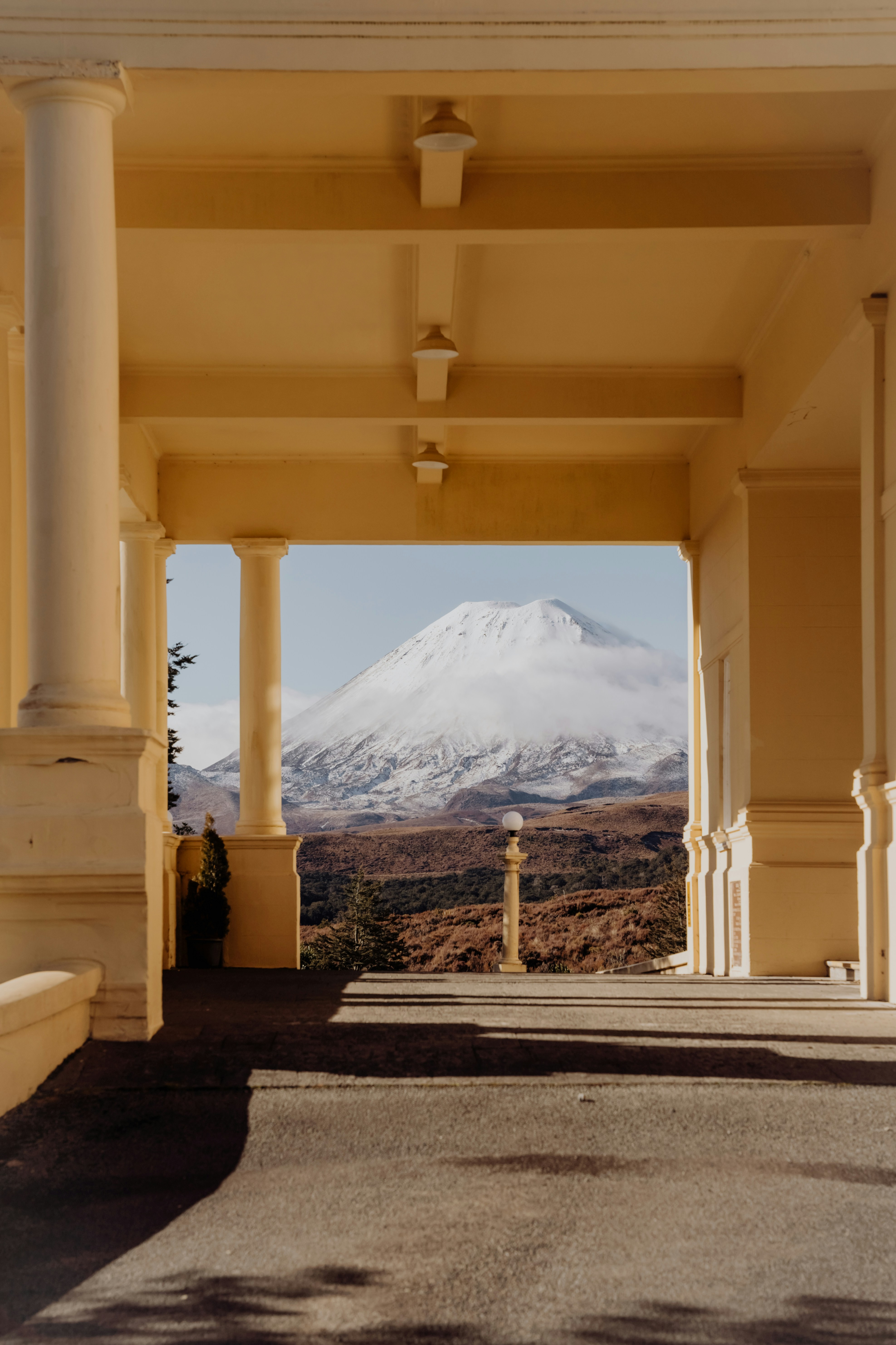 Sunlit Colonnade Framing a Snow-Capped Summit