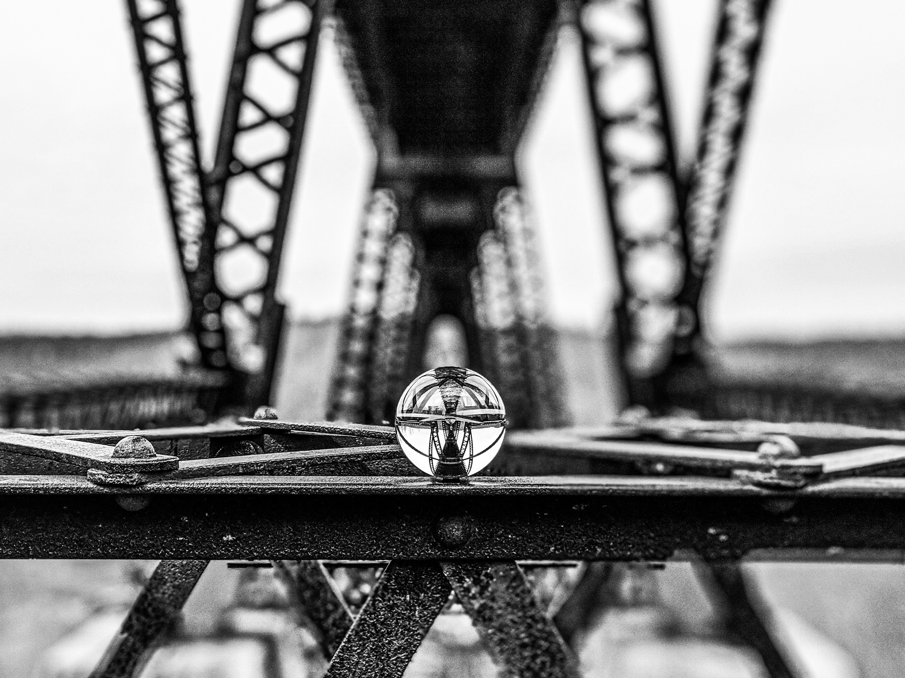 Crystal Sphere on a Steel Spire: A Close-Up of Perspective