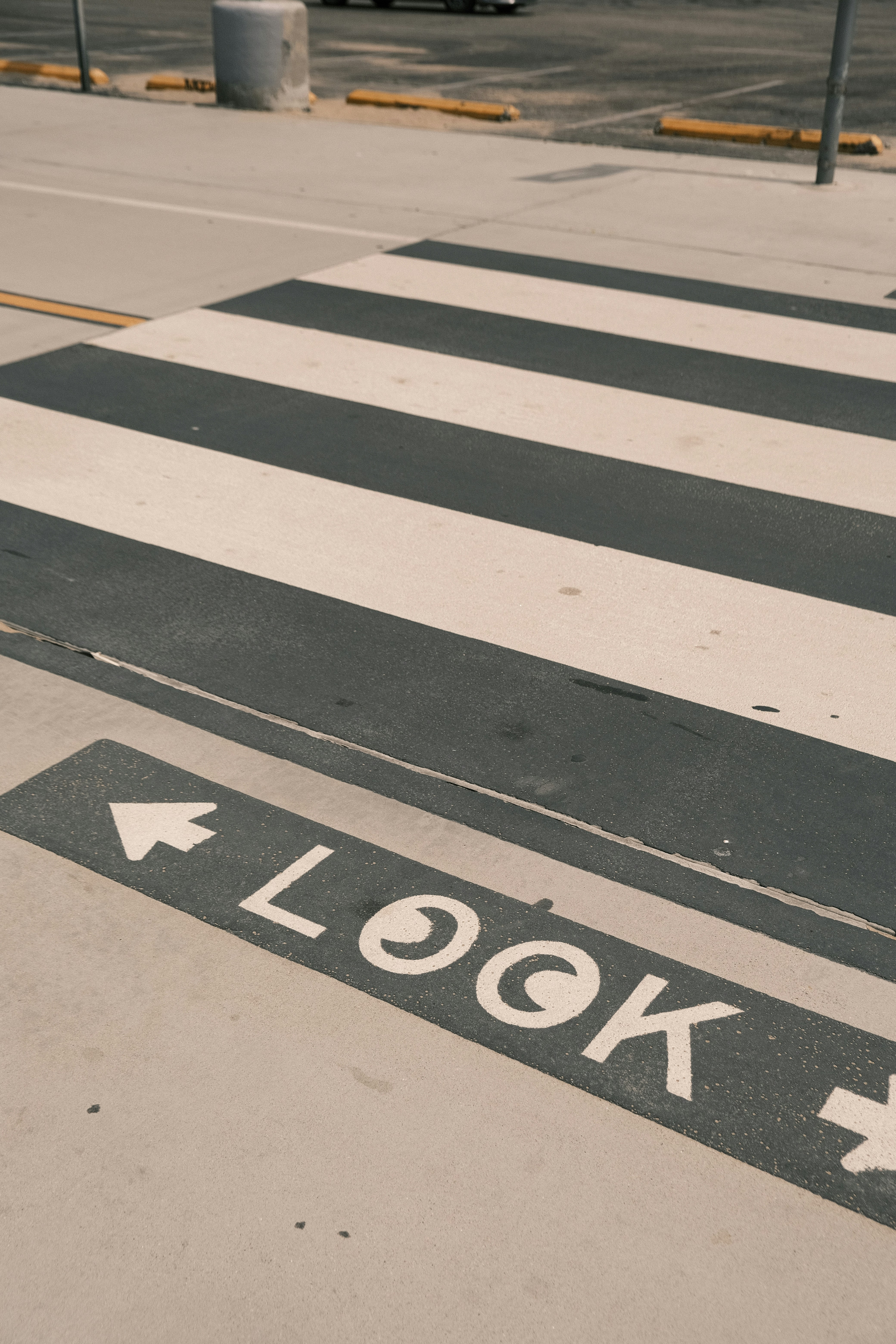 A crosswalk with a sign that says look photo – Free Asphalt Image on ...