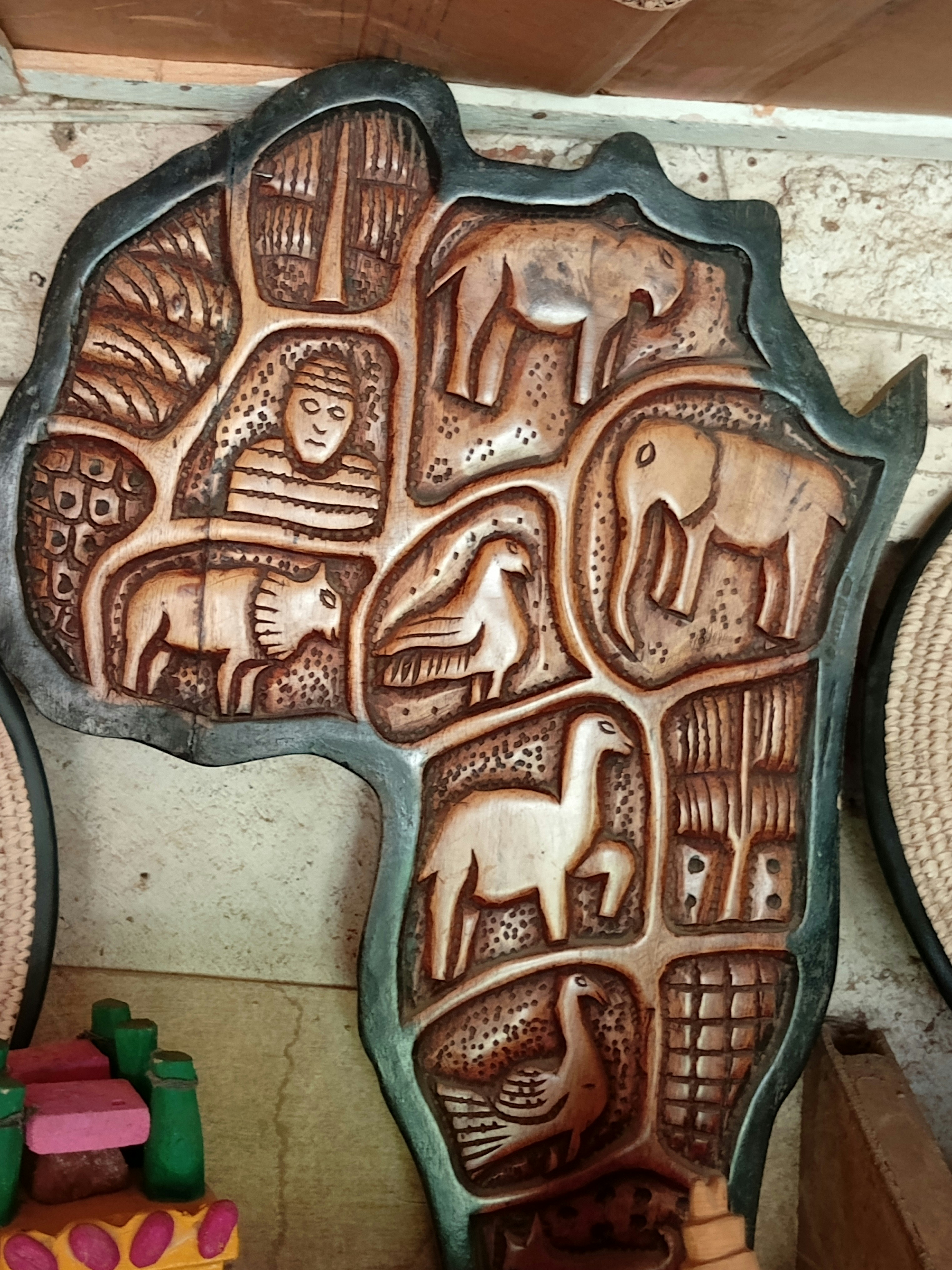 Africa in Wood: A Mosaic Relief Carving of Wildlife and People