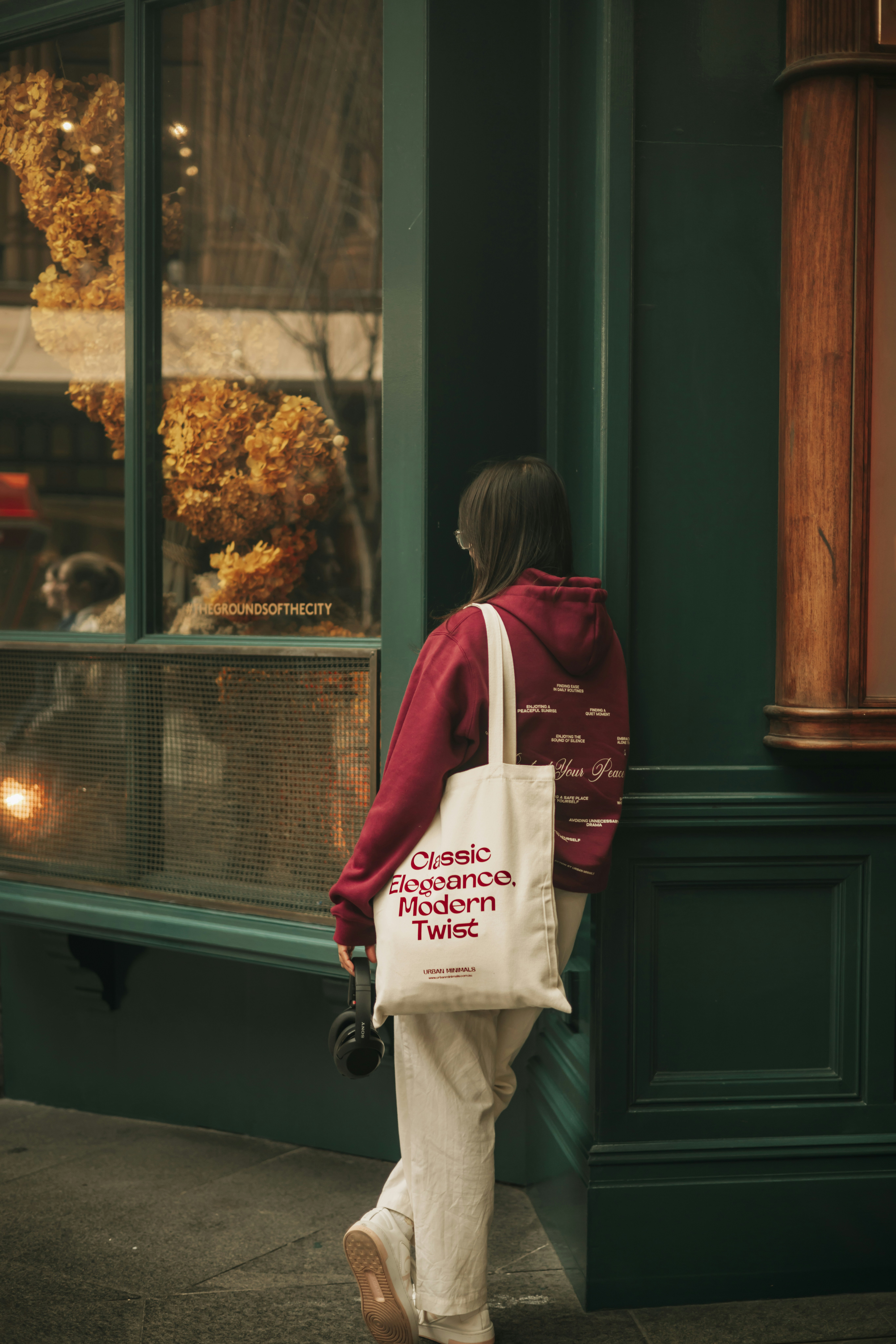 Burgundy Hoodie at a Verdant Corner: A Quiet City Portrait by Golden Florals