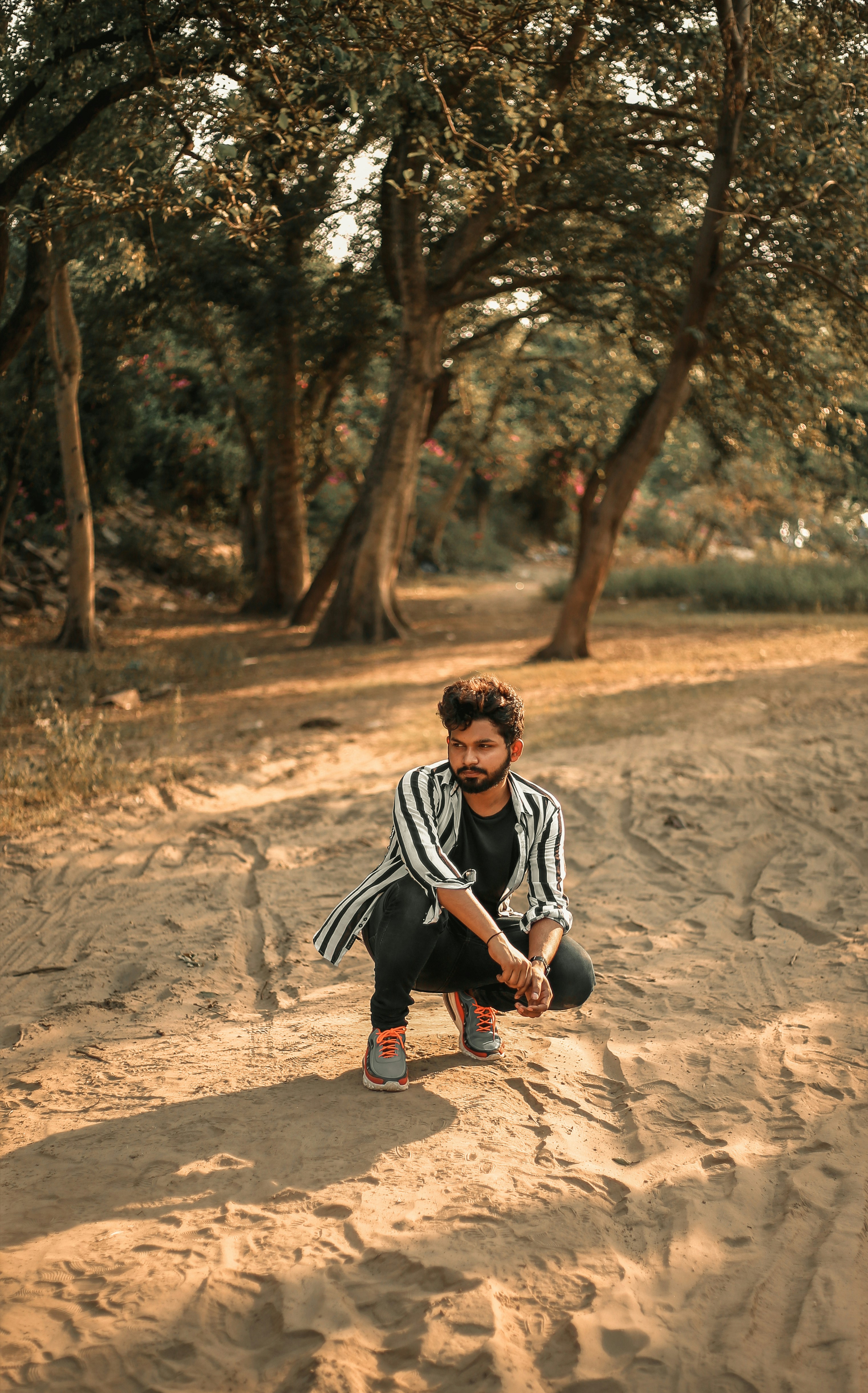 A man kneeling down in the sand with a baseball bat photo – Free Ravi ...