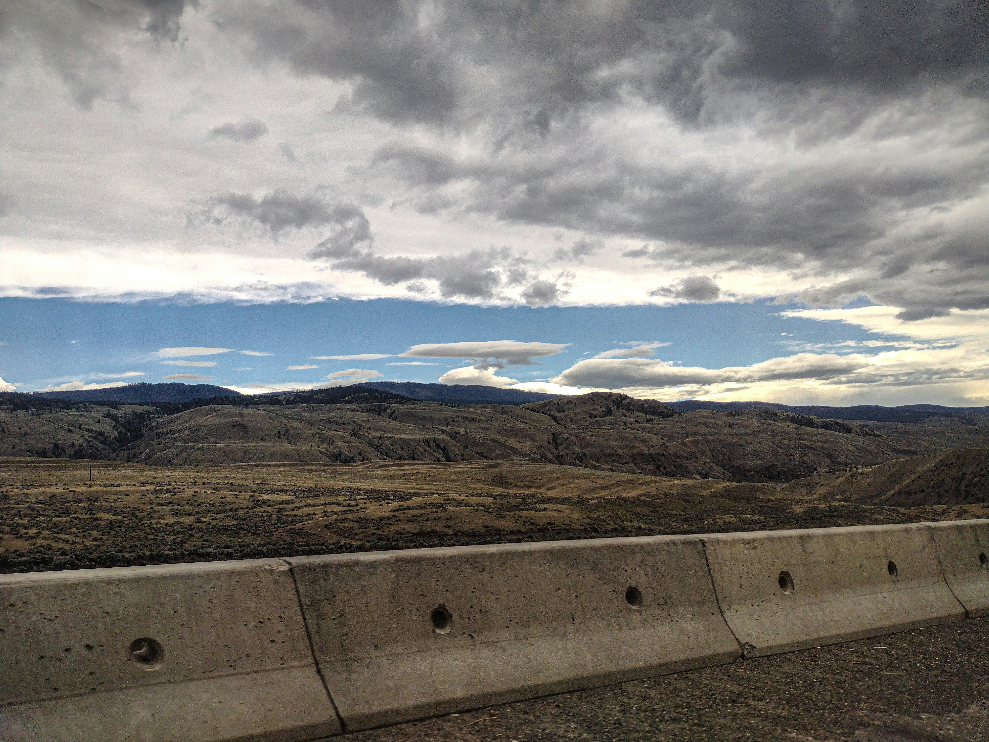 A view of a highway with mountains in the background