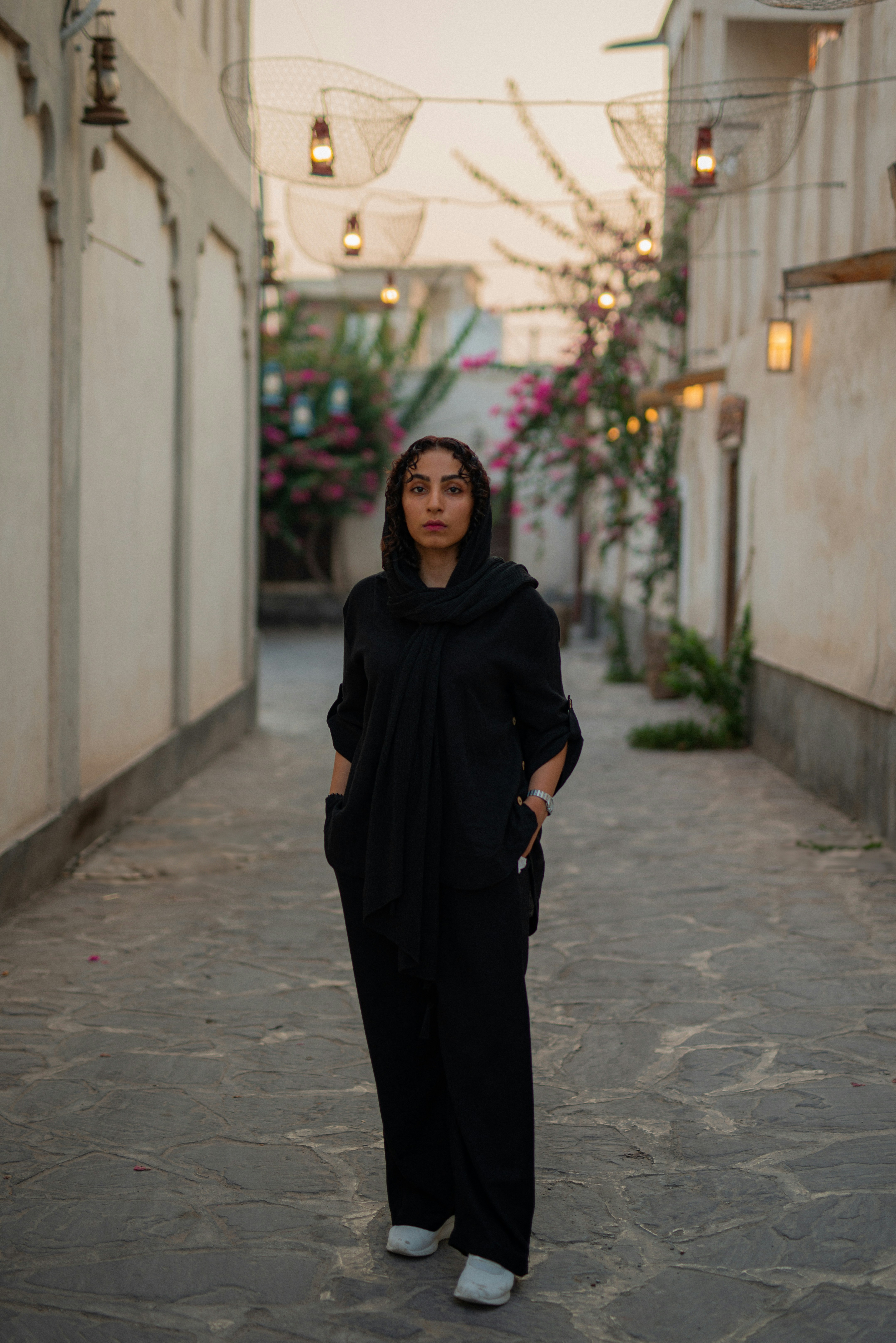 A woman in a black outfit is standing in an alley photo – Free Bandar ...