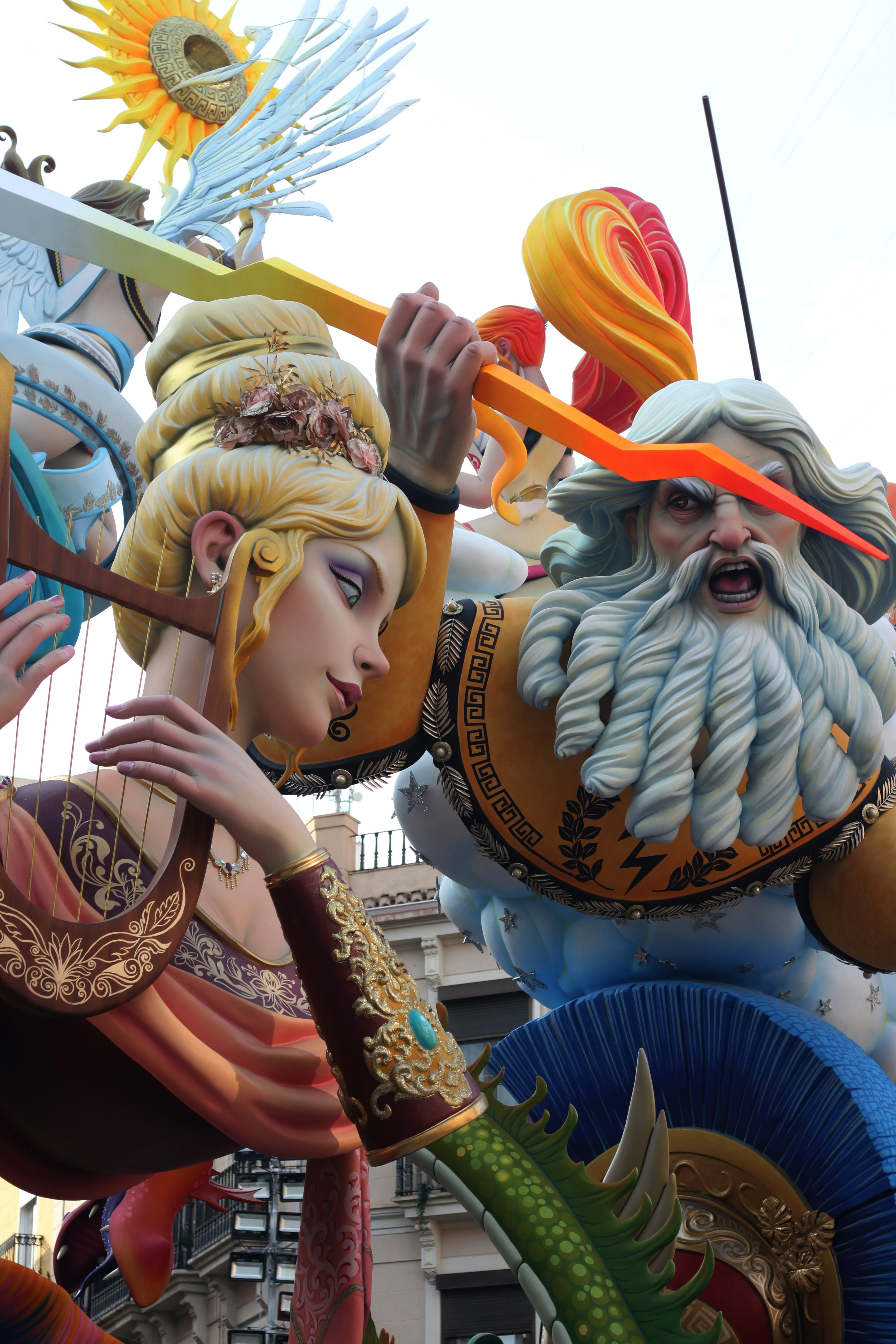 Heroic Sculptures in a Street Parade: A Blonde Muse and an Elder Warrior