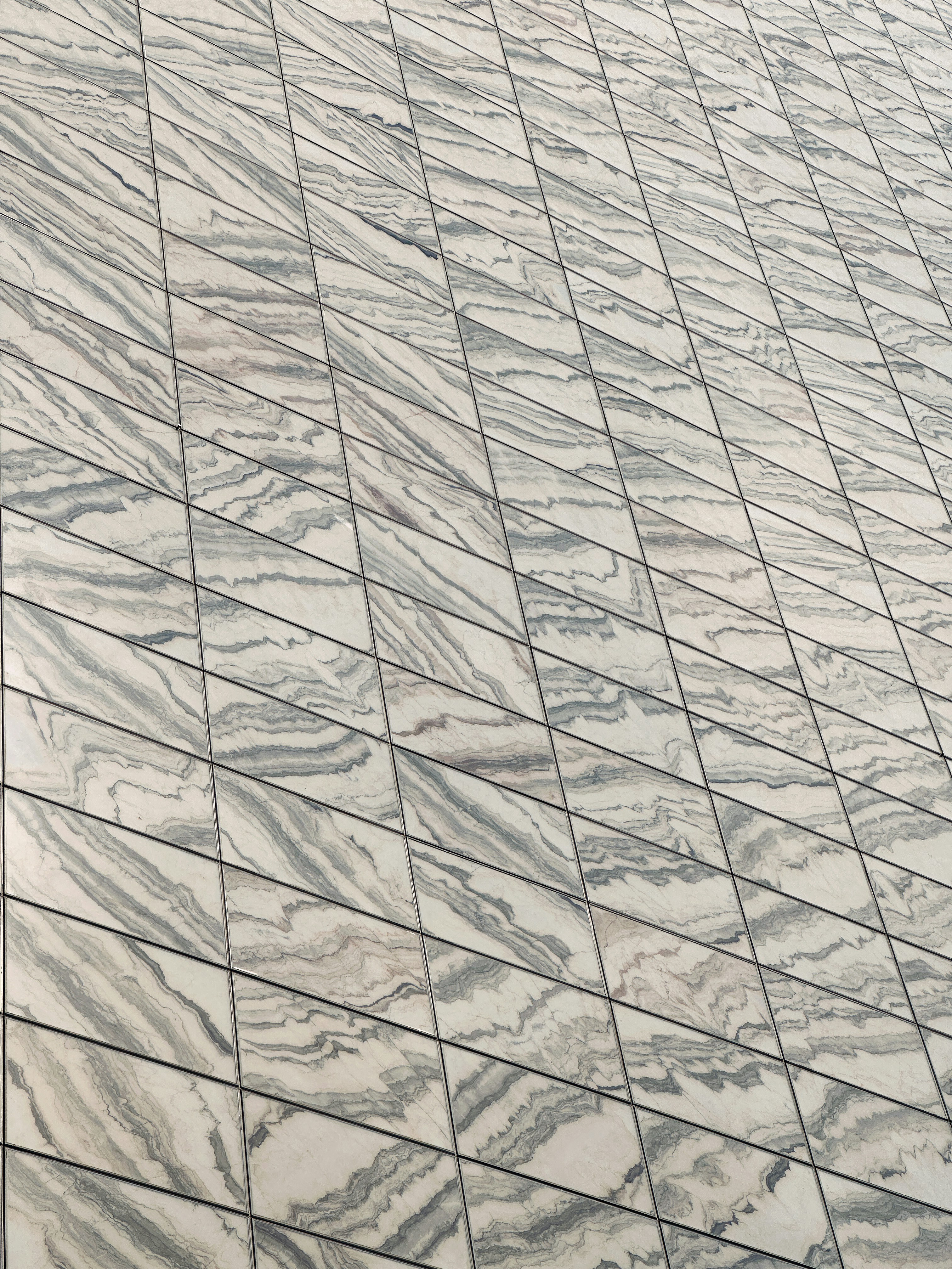 Diamond Veins: Marble Tile Lattice on a Quiet Facade