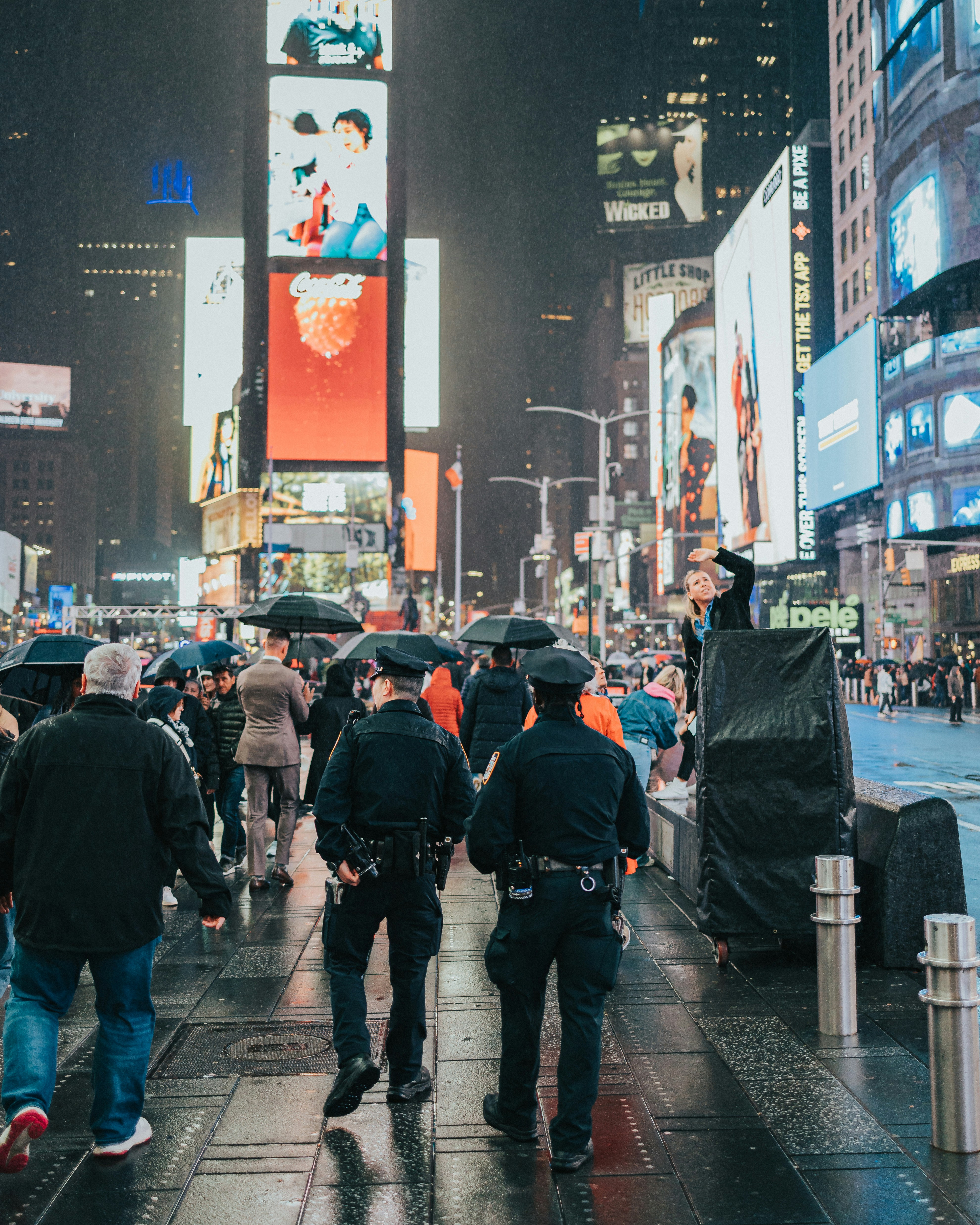 A group of police officers walking down a street photo – Free Manhattan ...