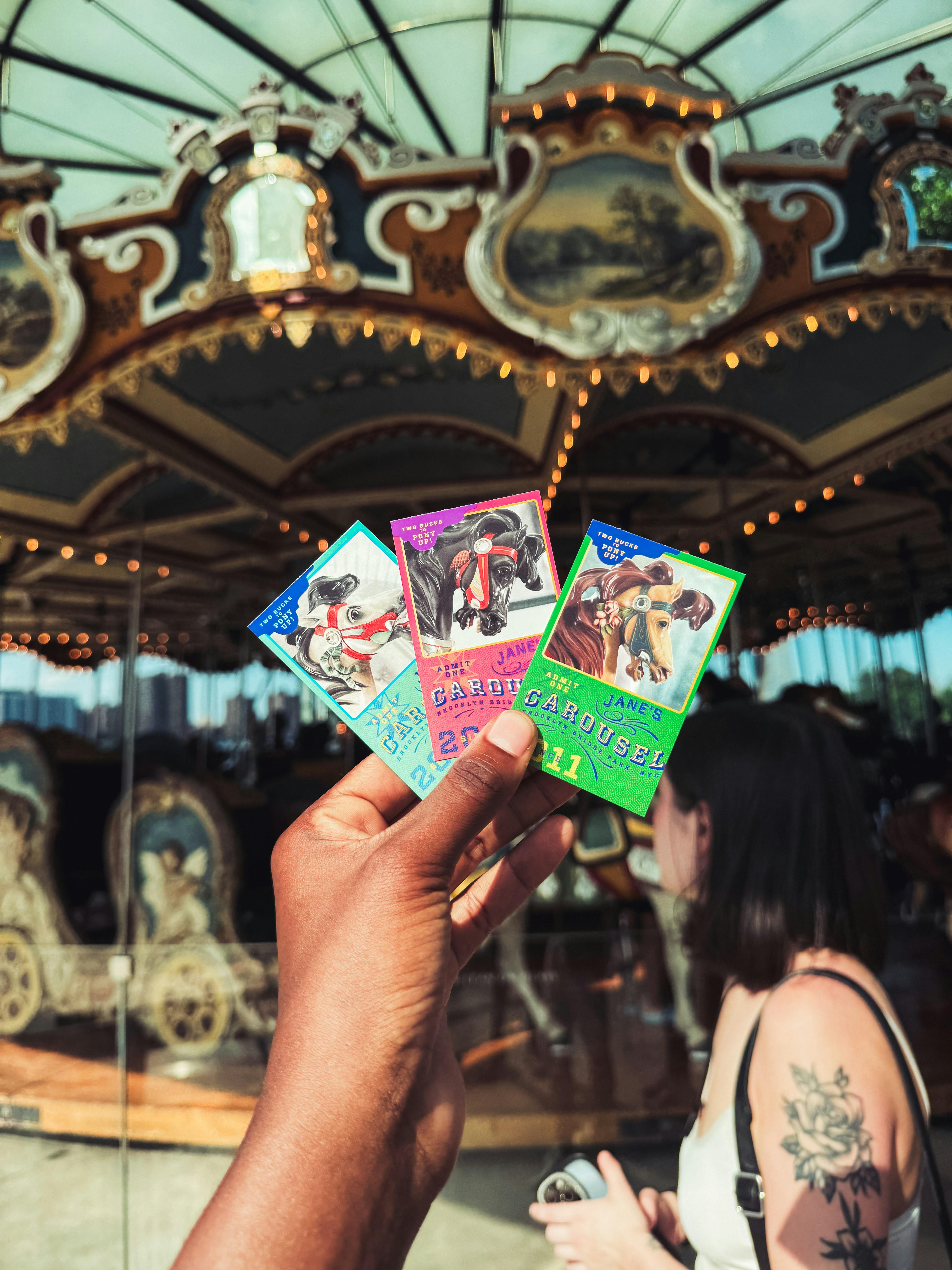 A person holding up cards in front of a carousel photo – Free Date ...
