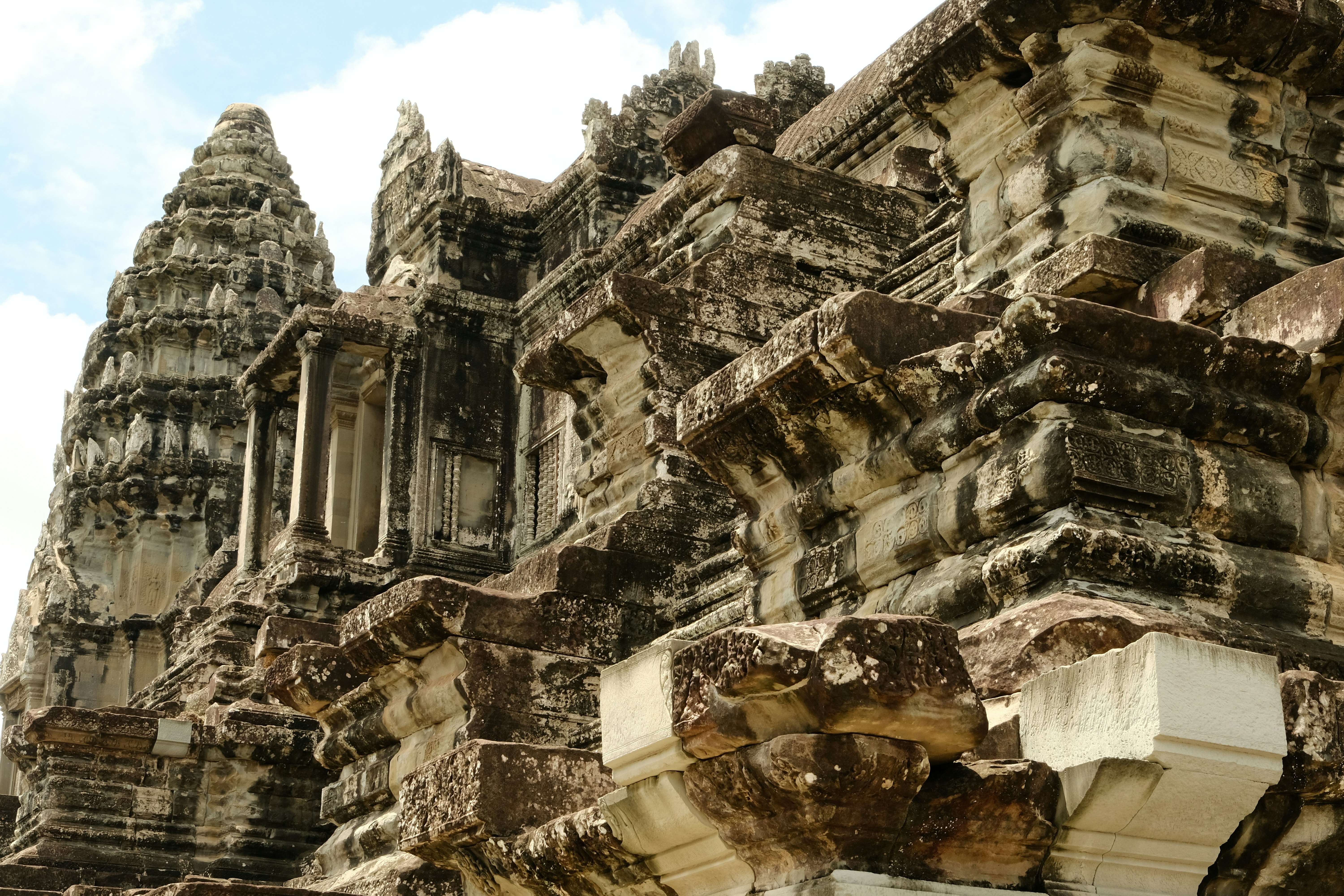A large stone building with a clock on it's side photo – Free Angkor ...