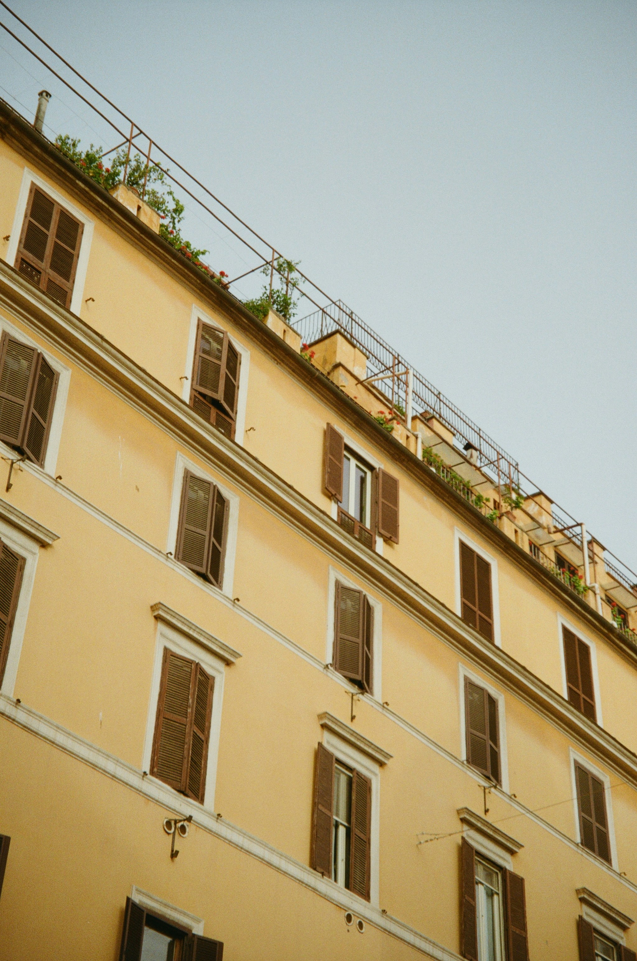 A tall yellow building with lots of windows photo – Free Rome Image on ...