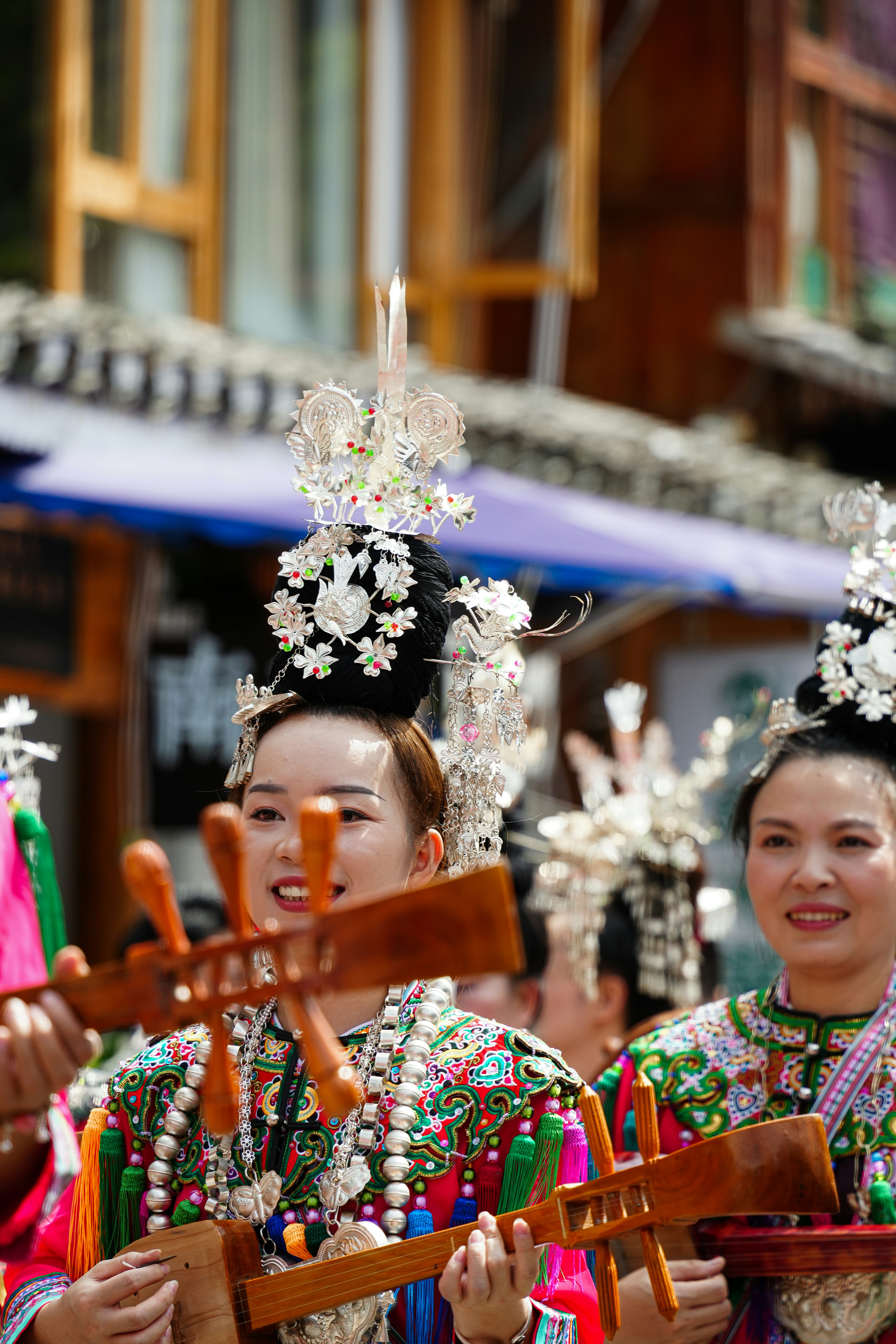 A group of women in colorful outfits holding musical instruments photo ...