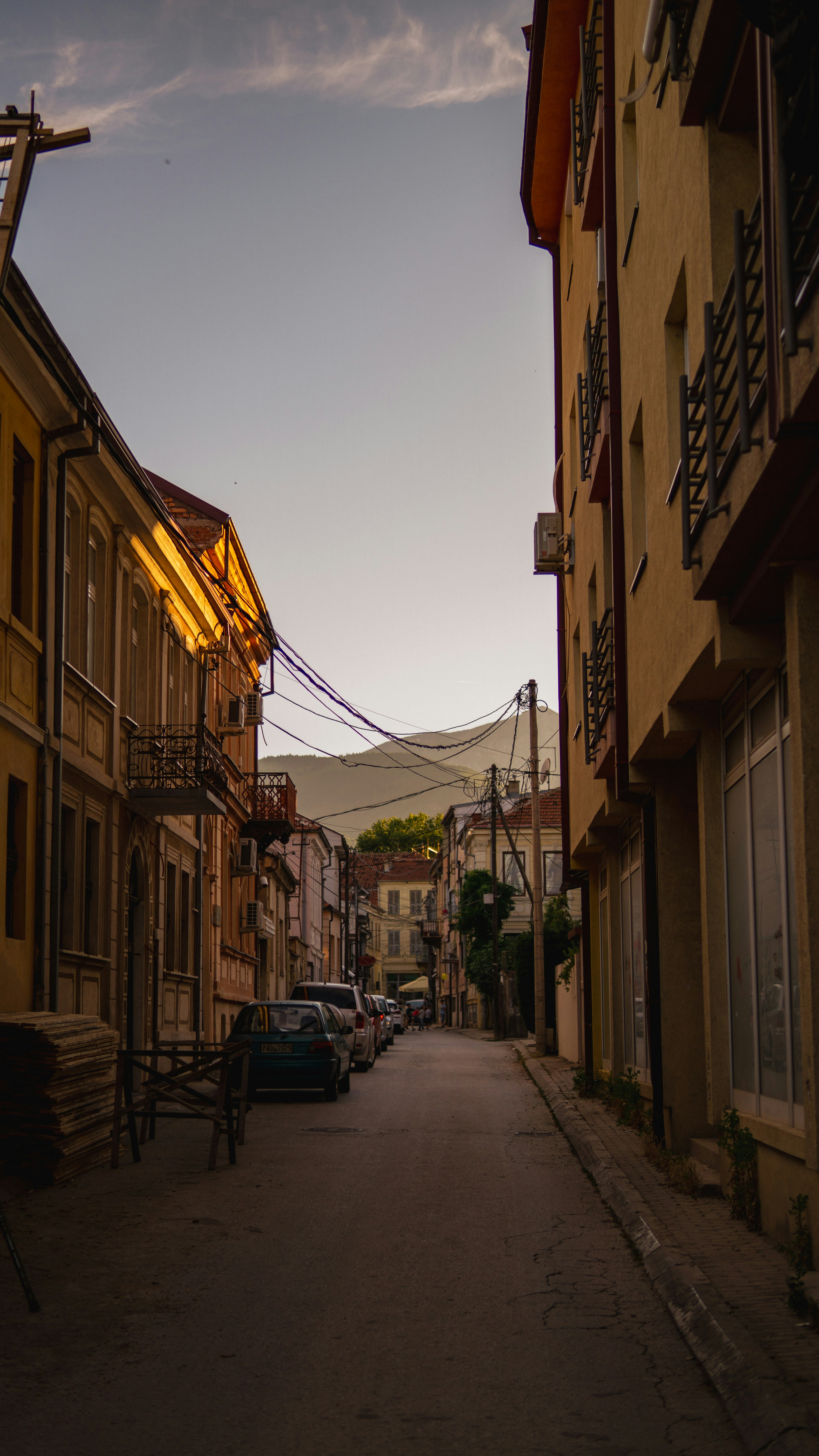 A narrow city street lined with tall buildings photo – Free Grey Image ...