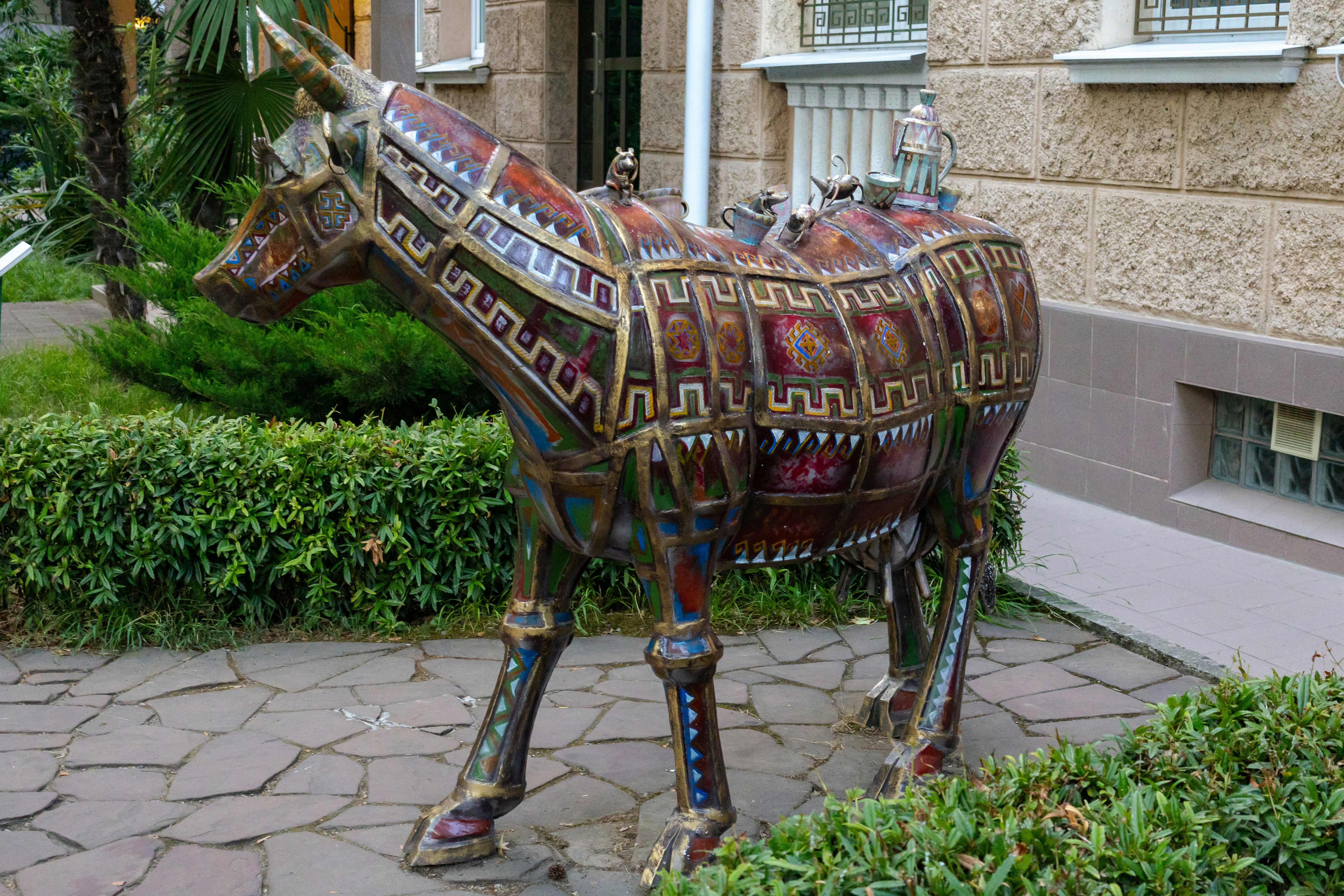 Kaleidoscopic Shimmer: A Metal Donkey Sculpture in a Quiet Courtyard