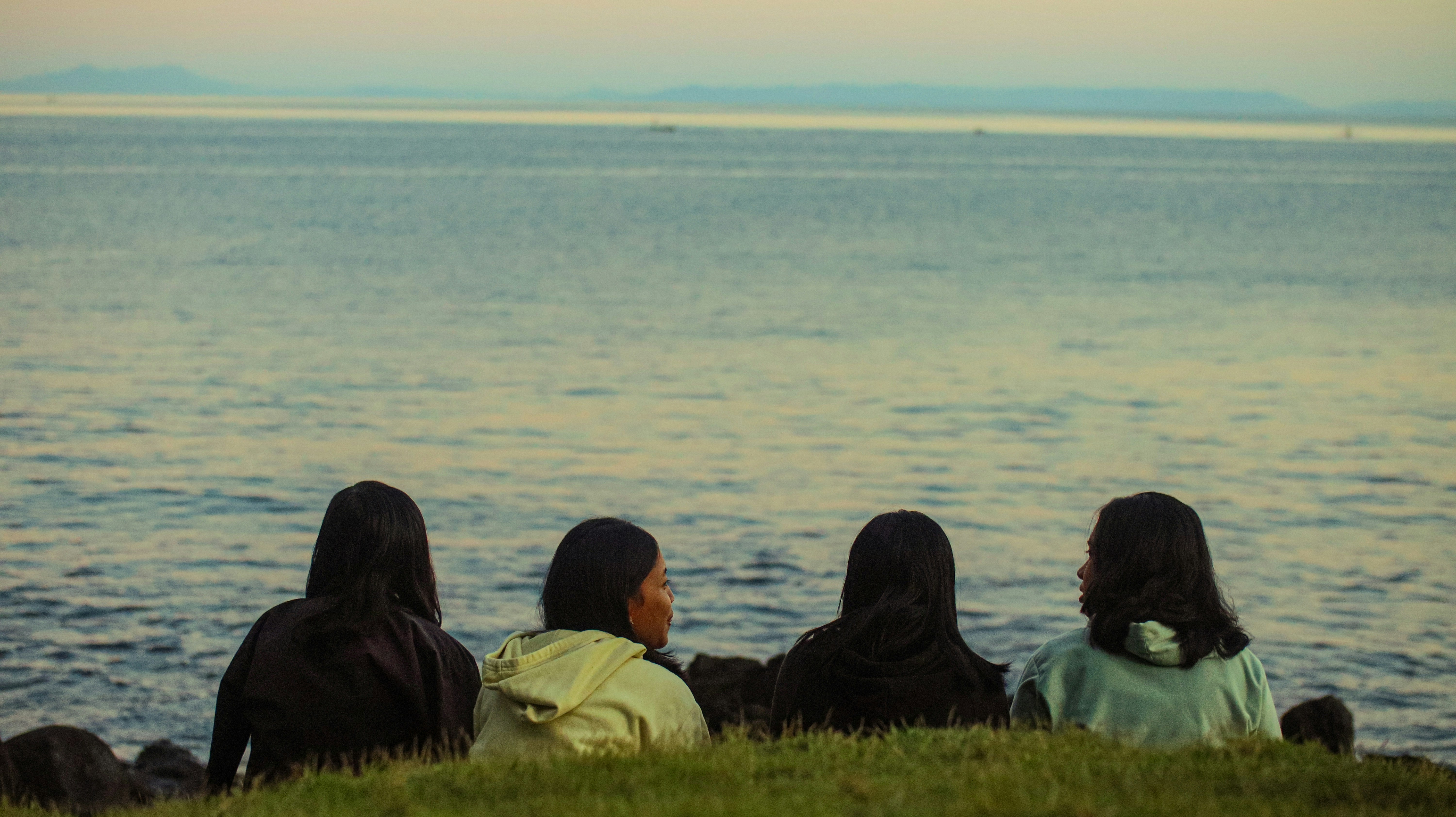 Quiet Convergence: Friends in Conversation by the Sea
