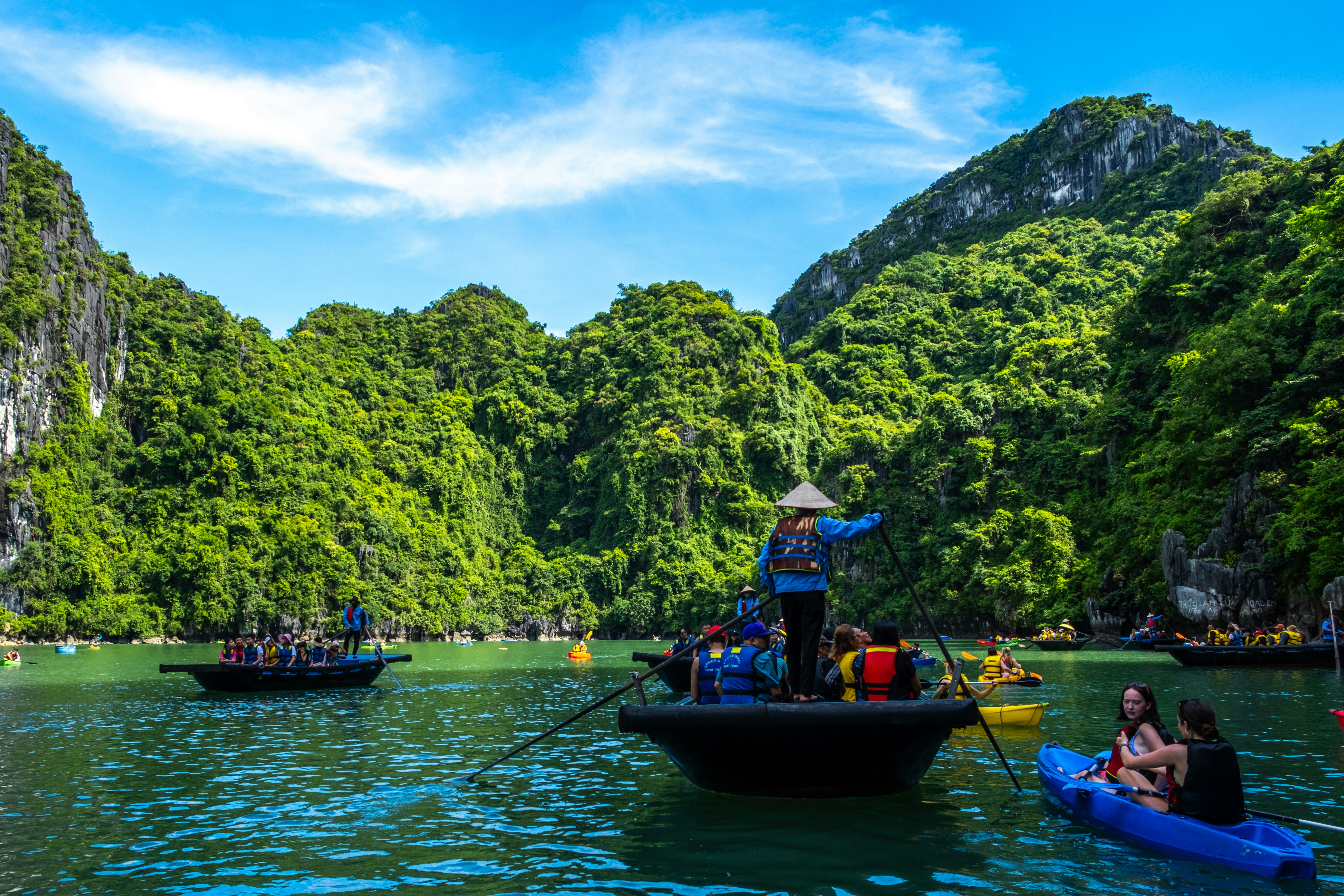 A group of people riding on top of boats in the water photo – Free ...