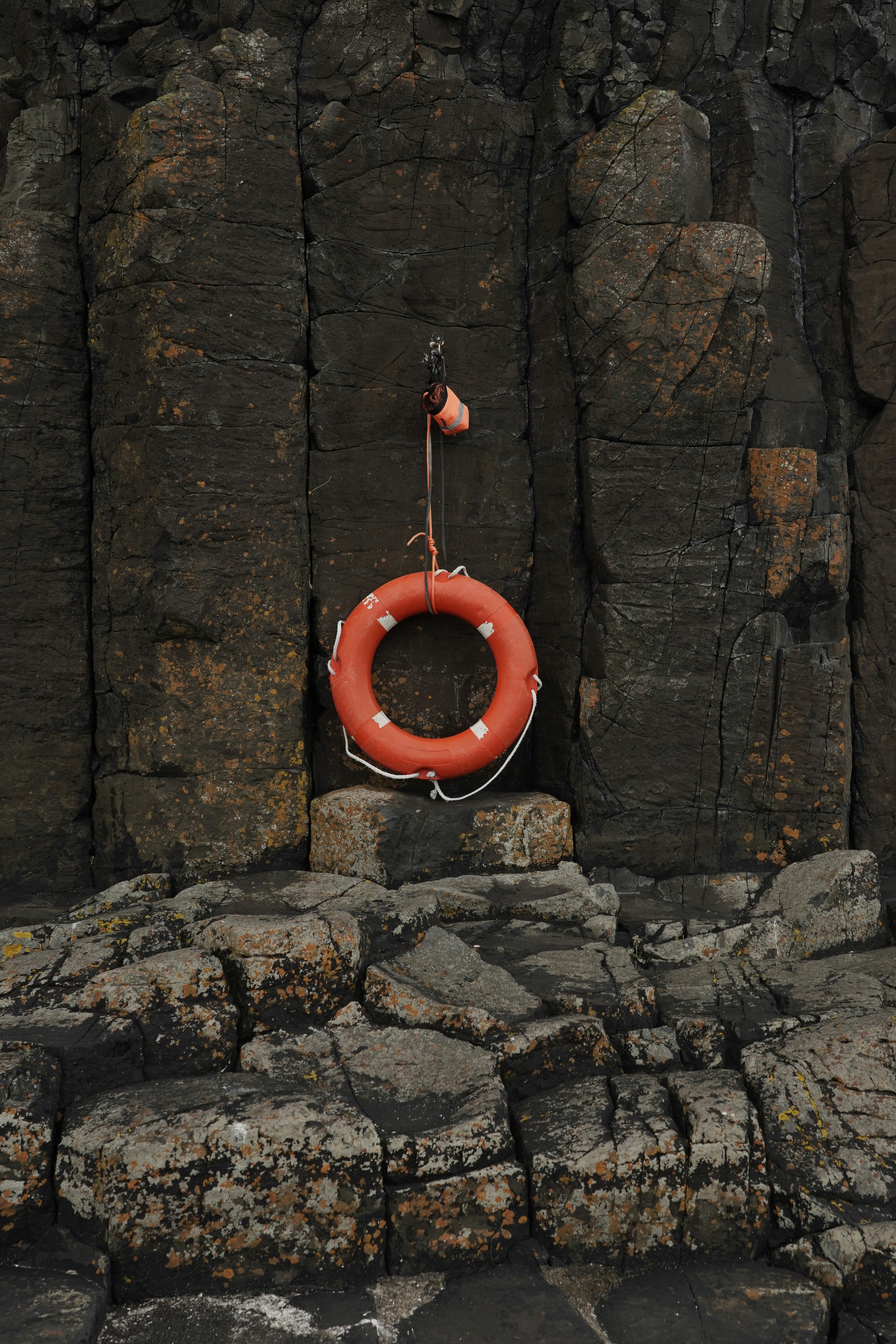 Lifebuoy on a Rugged Cliff: Quiet Sentinel of the Shore