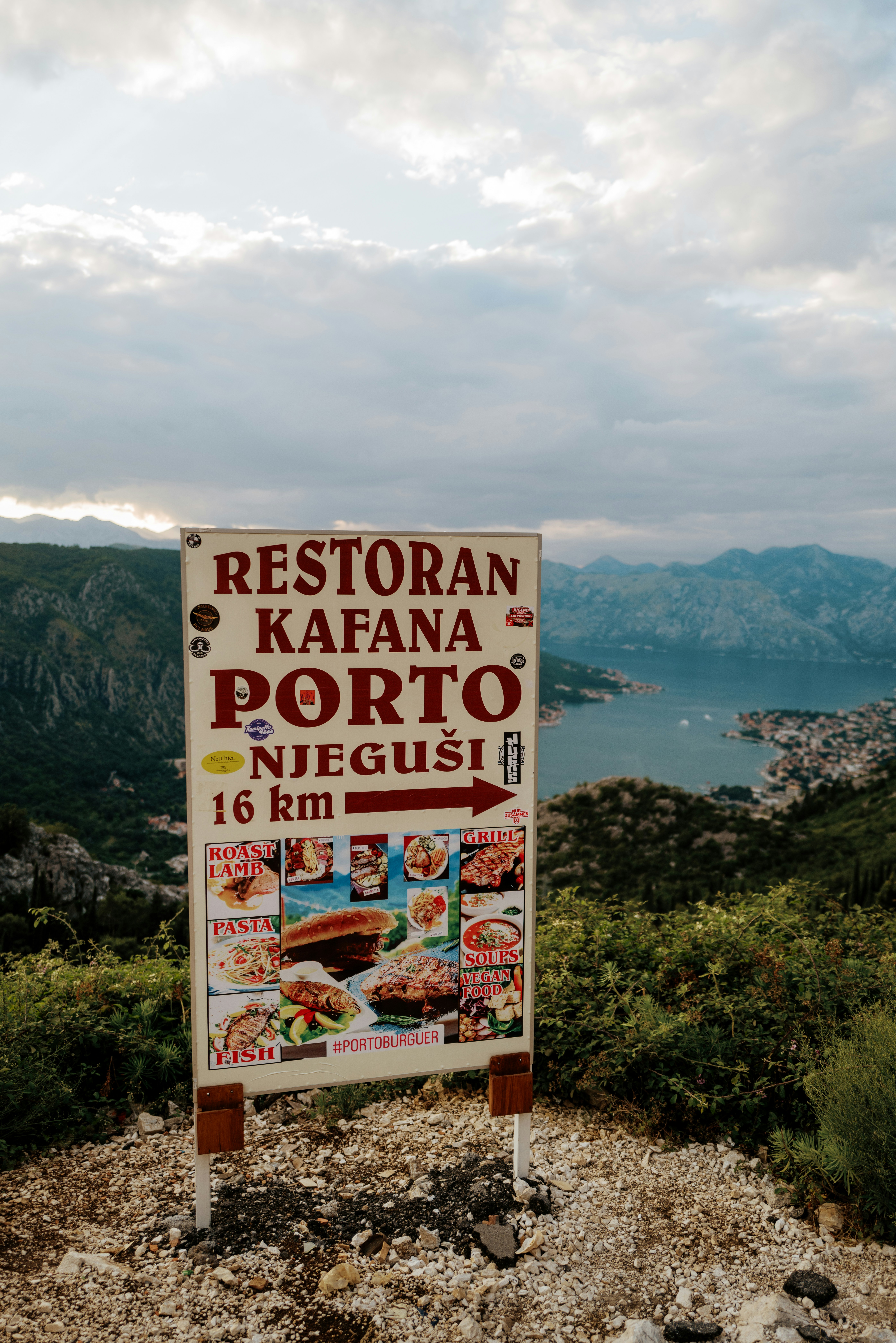 Cliffside Signpost Framing a Montenegrin Adriatic Panorama