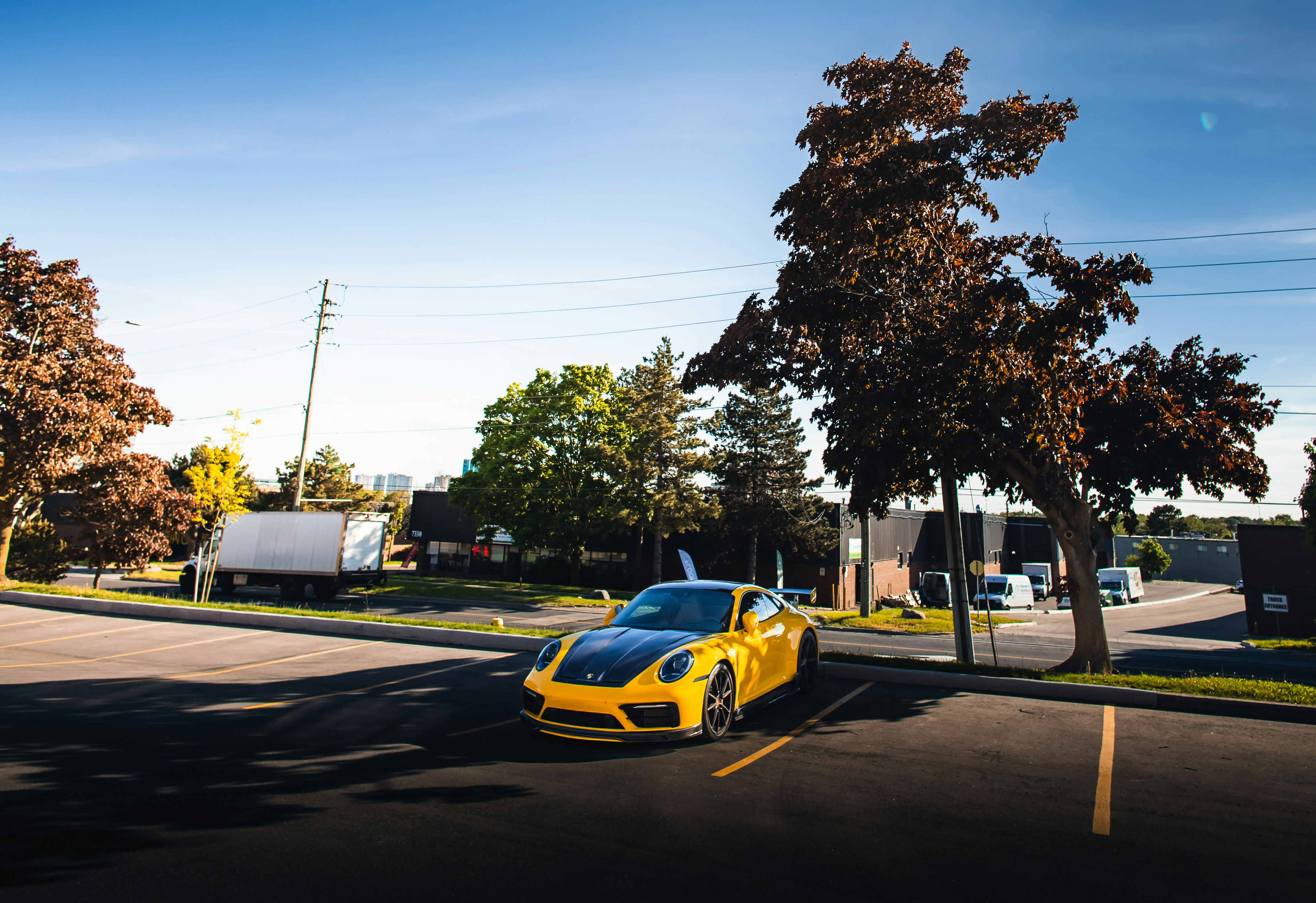 A yellow sports car parked in a parking lot photo – Free Car Image on ...